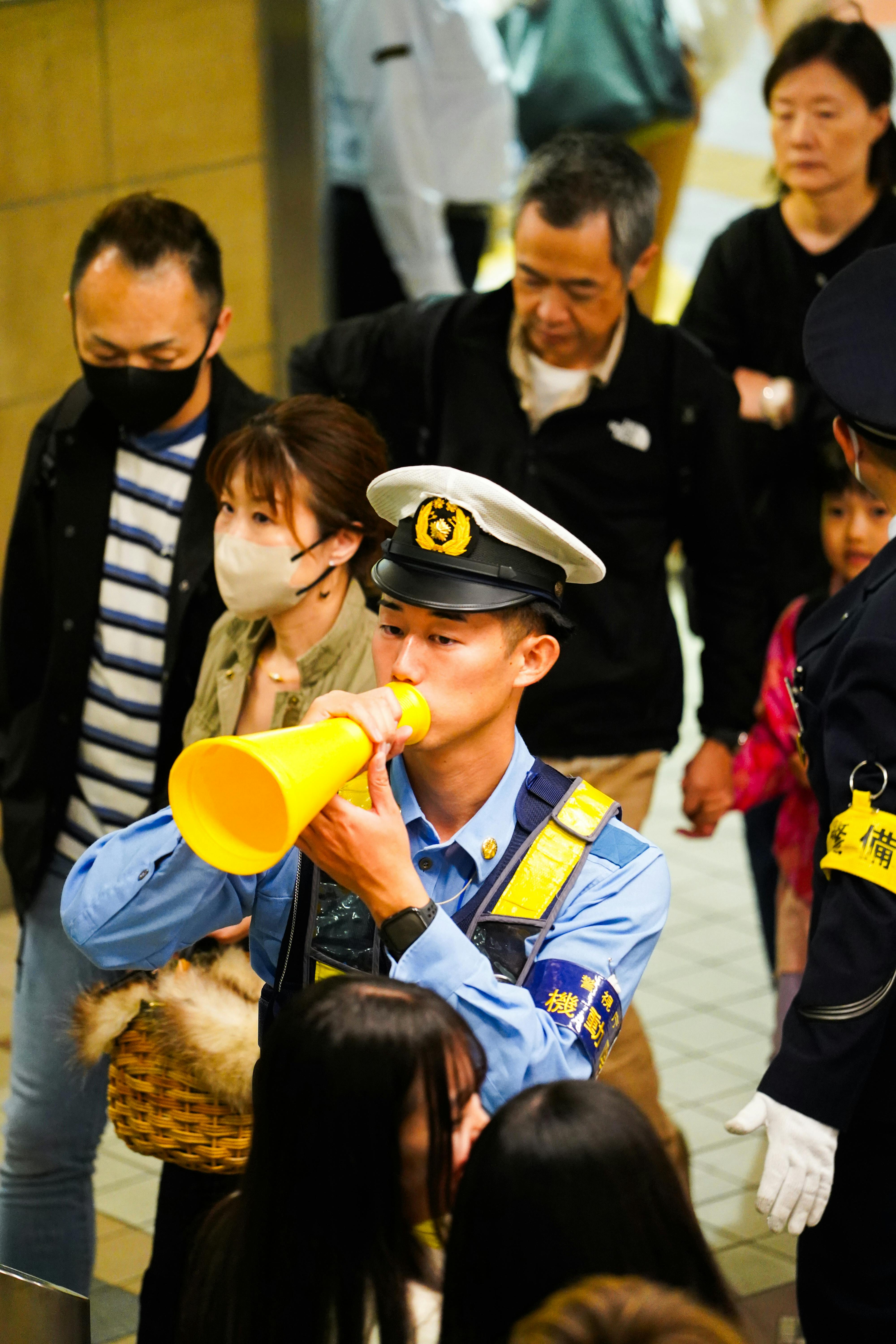 Japanese Police Guiding Crowd in Tokyo Subway · Free Stock Photo