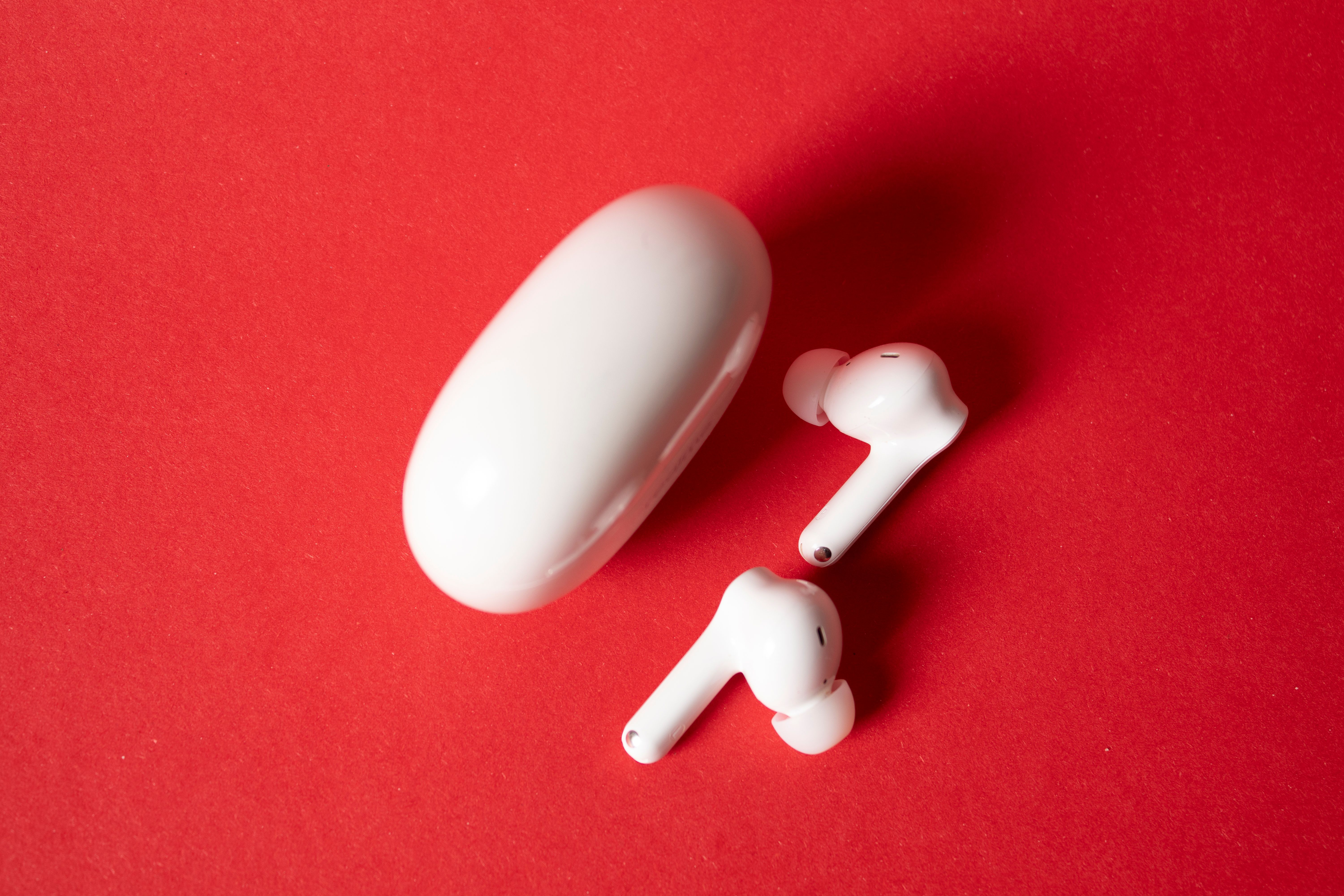 Minimalist White Earbuds on Red Background · Free Stock Photo