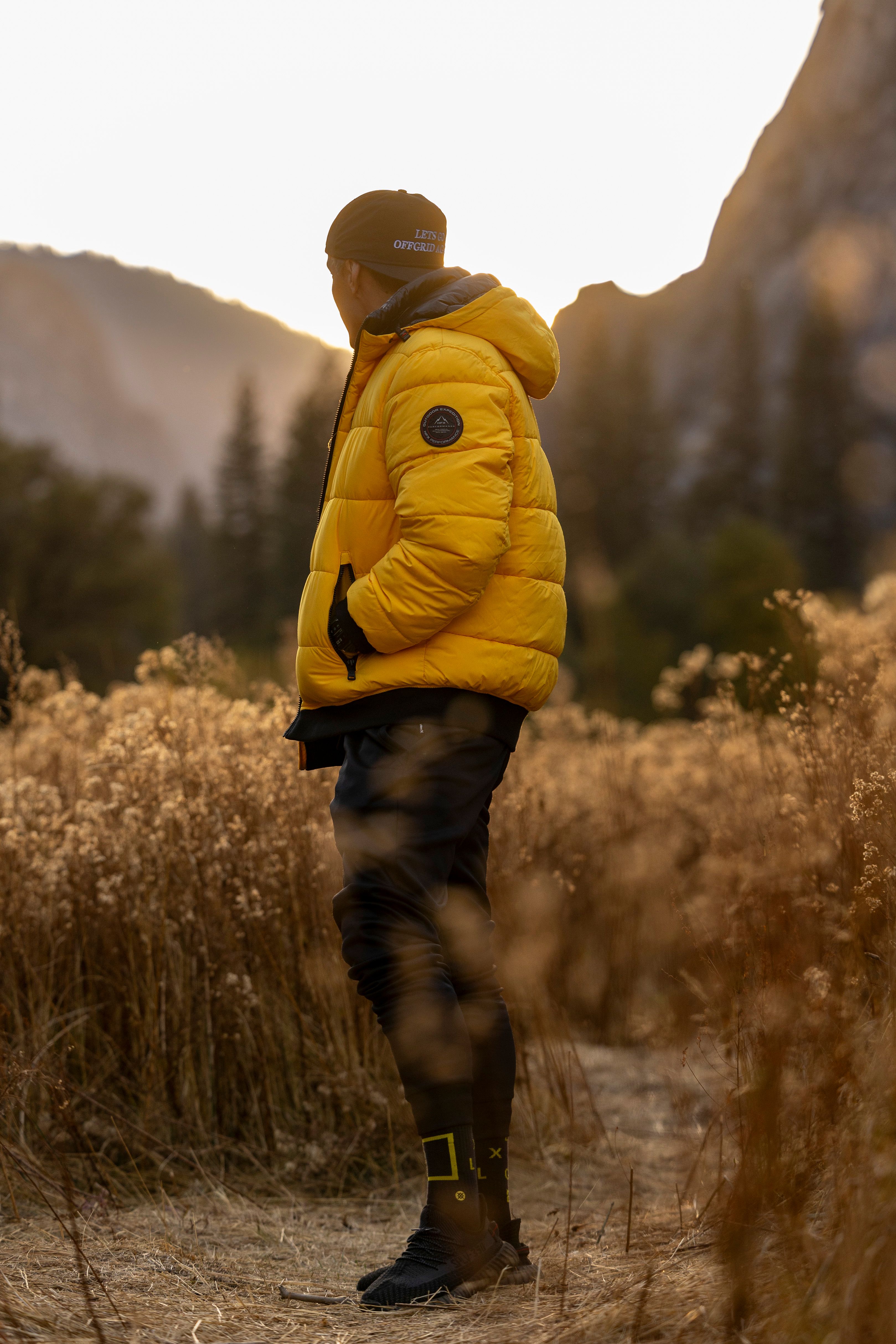 Person in Yellow Jacket Exploring Scenic Outdoors · Free Stock Photo