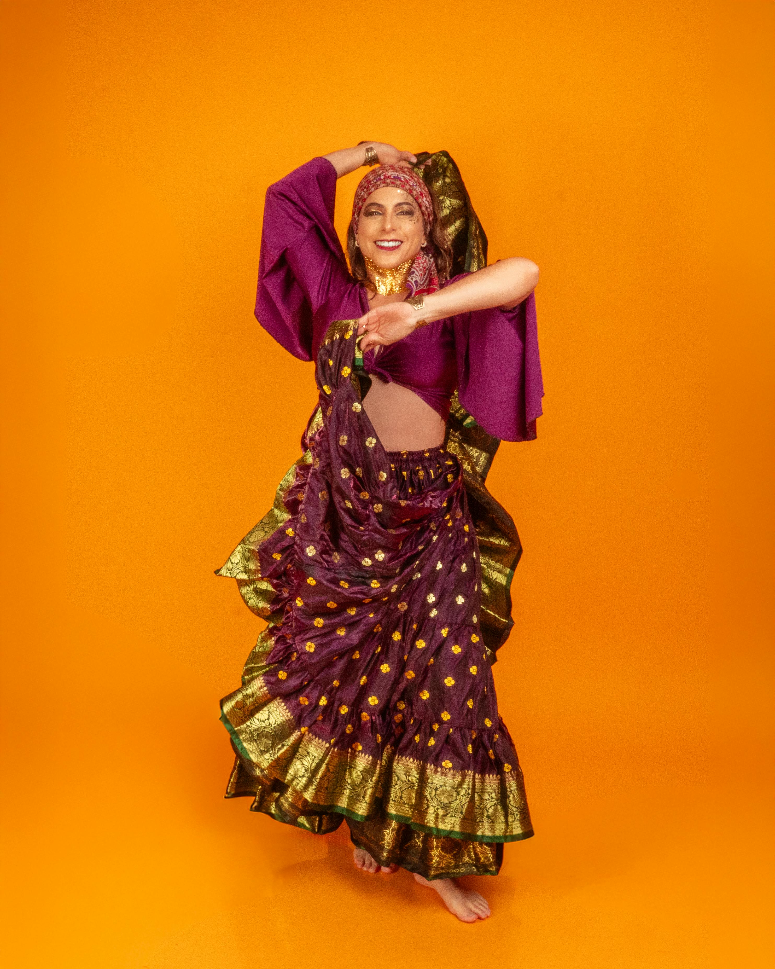 Vibrant Gypsy Dance in Orange and Purple Attire · Free Stock Photo