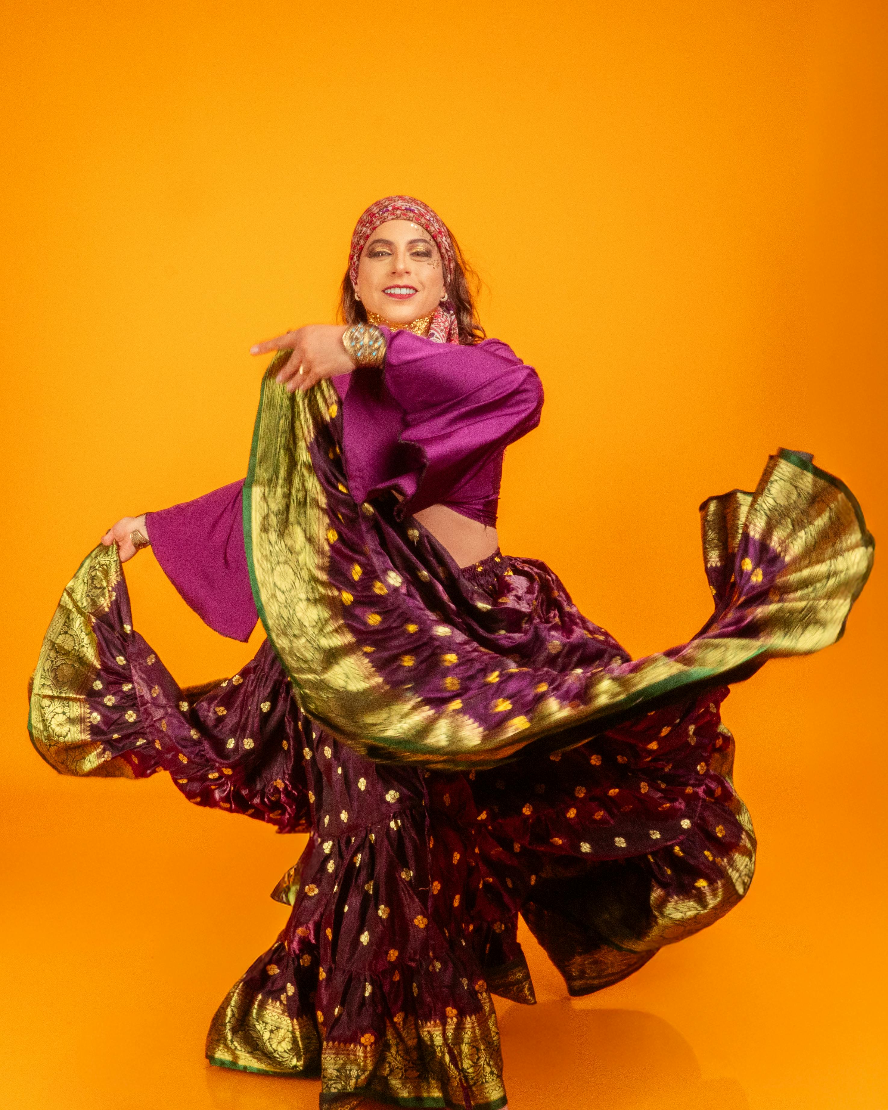 Vibrant Romani Dance in Orange Studio · Free Stock Photo