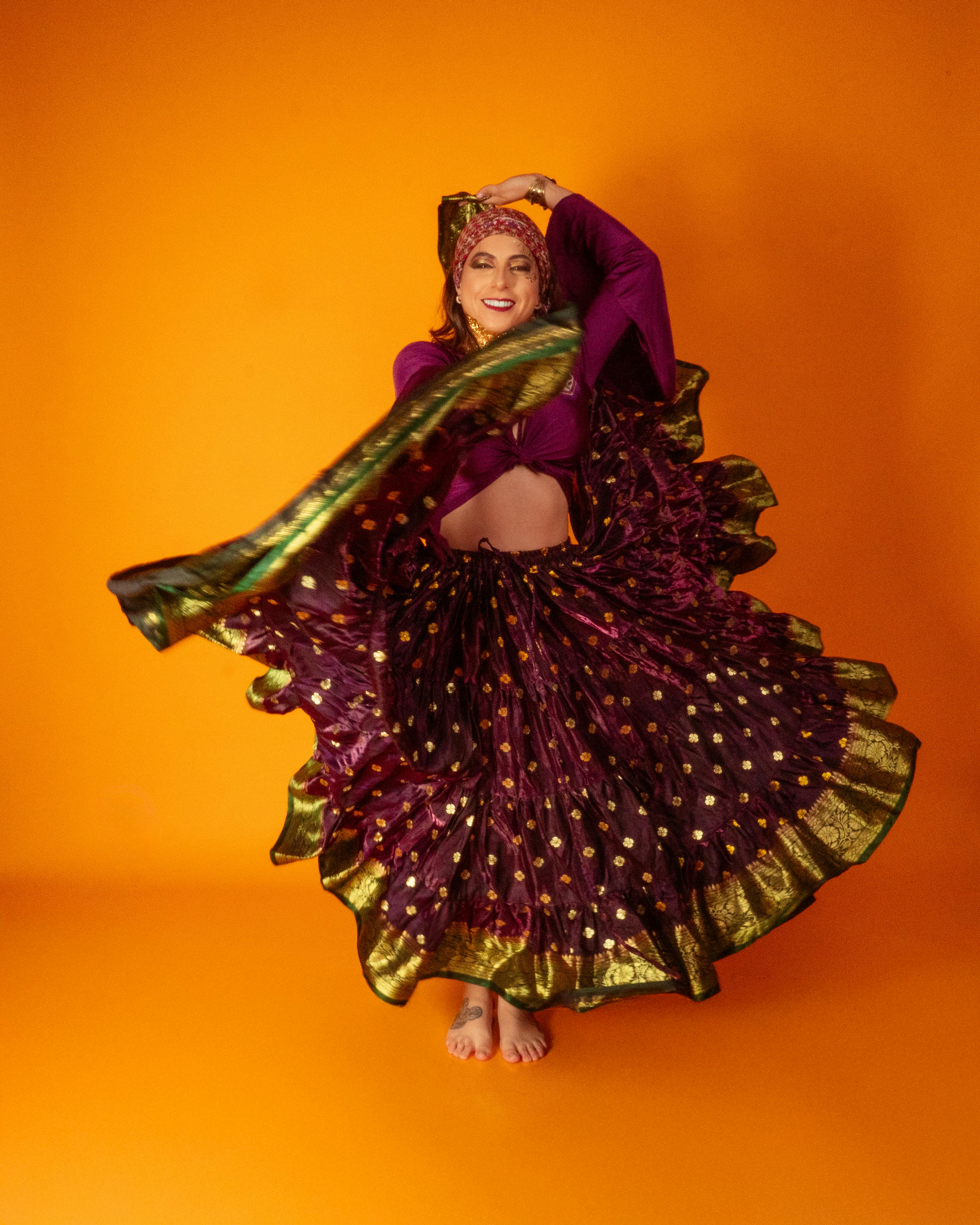 Graceful Dancer in Vibrant Purple and Gold Costume · Free Stock Photo