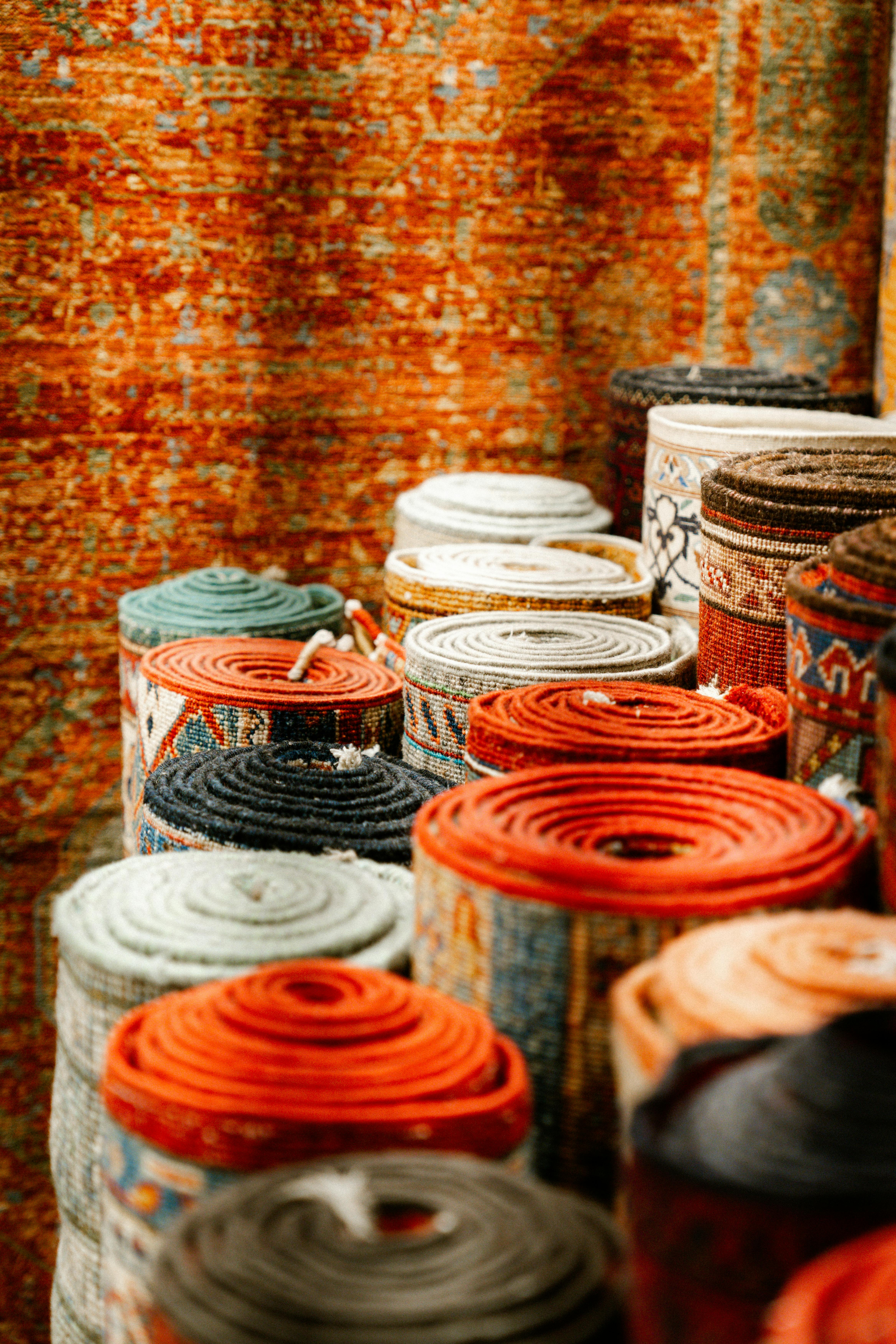 Colorful Rolled Persian Rugs on Display · Free Stock Photo