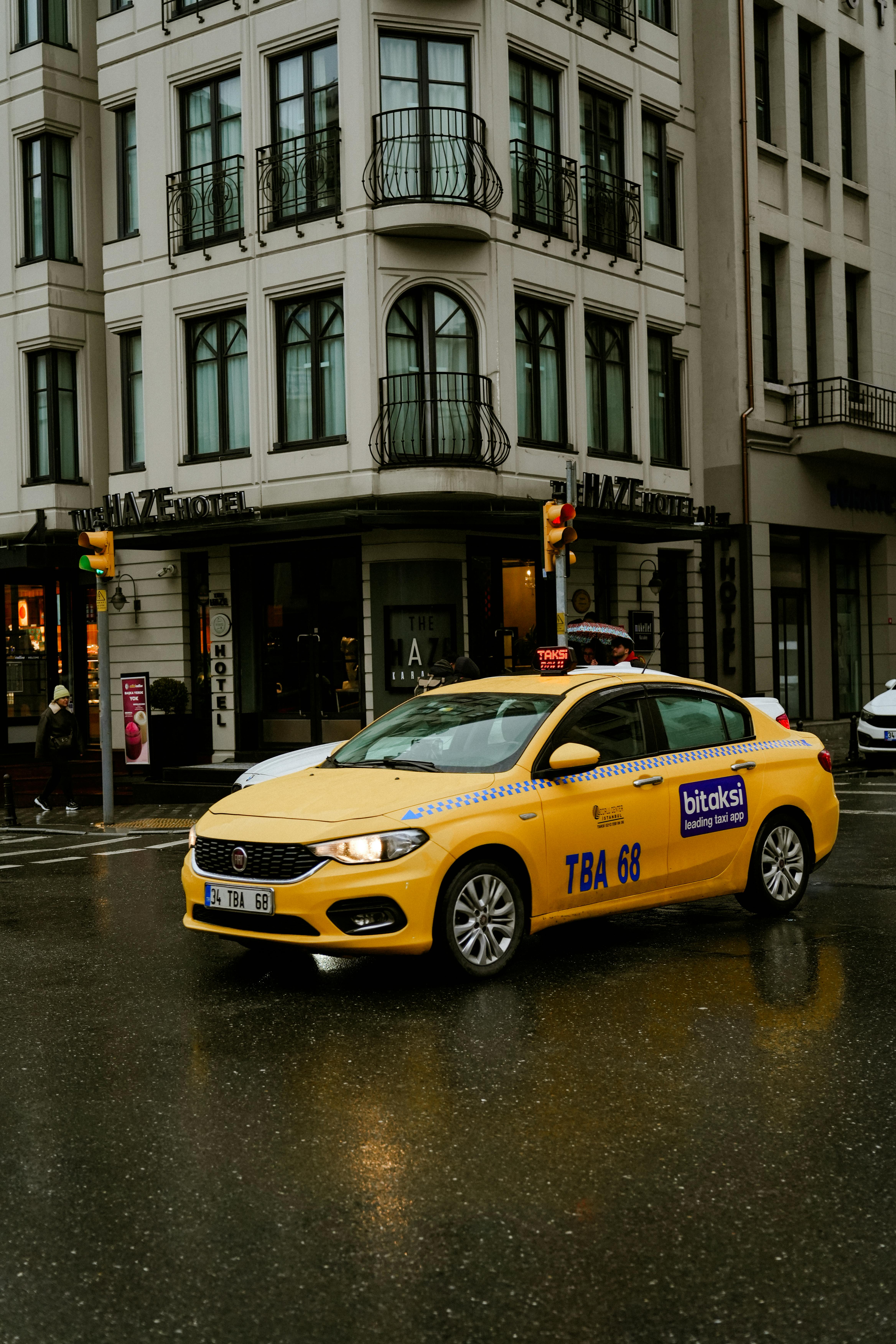 Different Vehicles on Road Near Concrete Buildings · Free Stock Photo