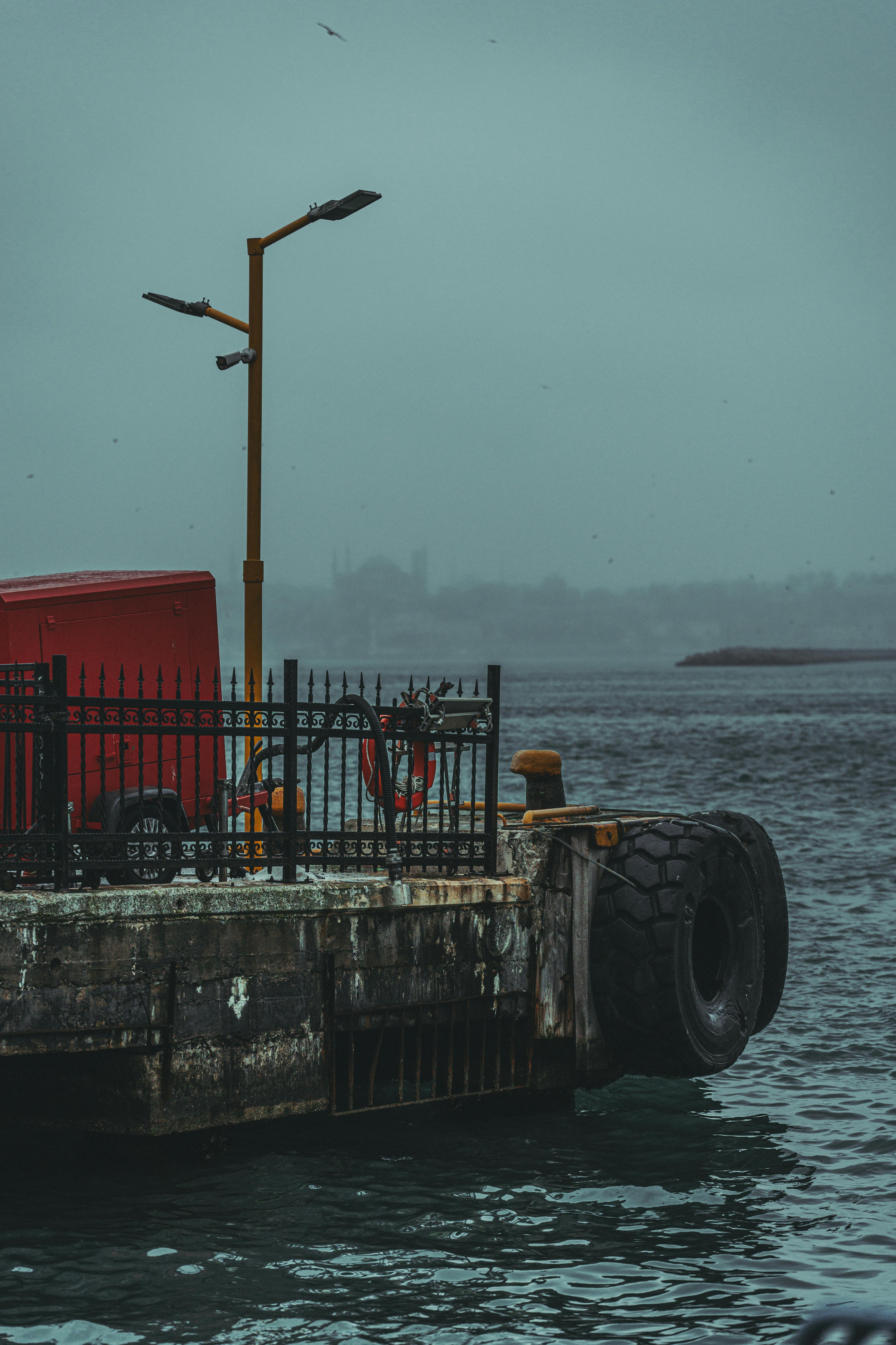 Moody Seaside Dock with Vintage Lamp Post · Free Stock Photo