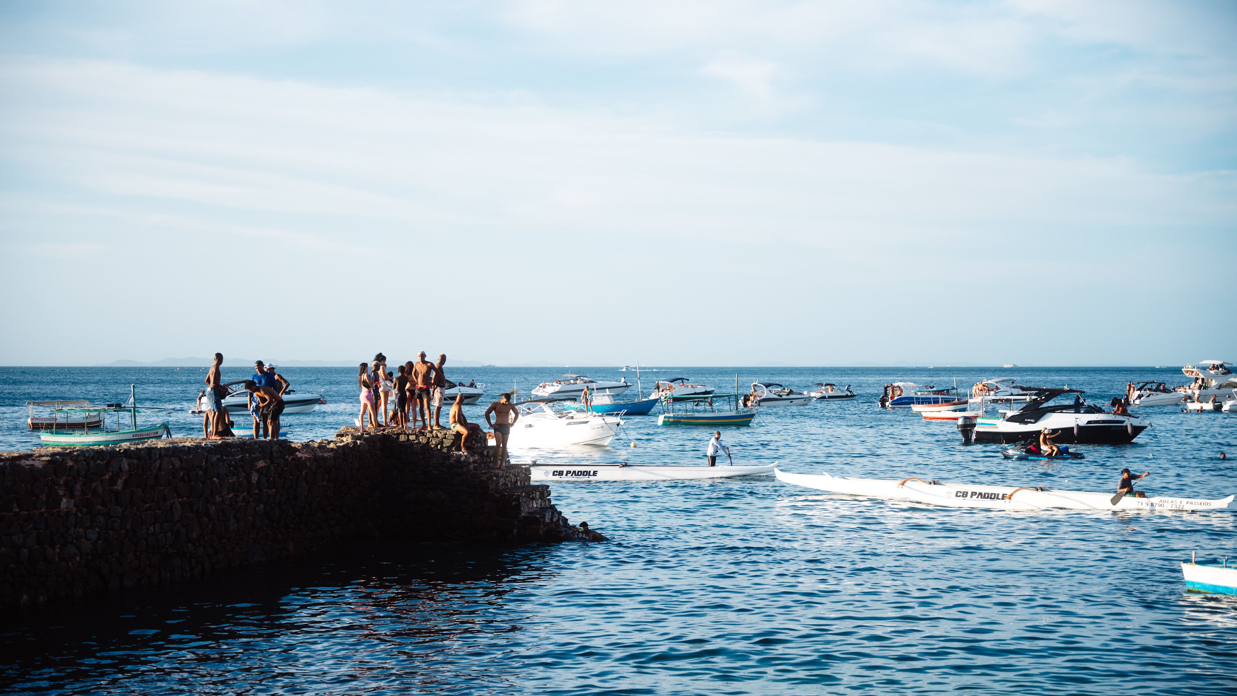 Summertime Gathering at the Waterfront with Boats · Free Stock Photo