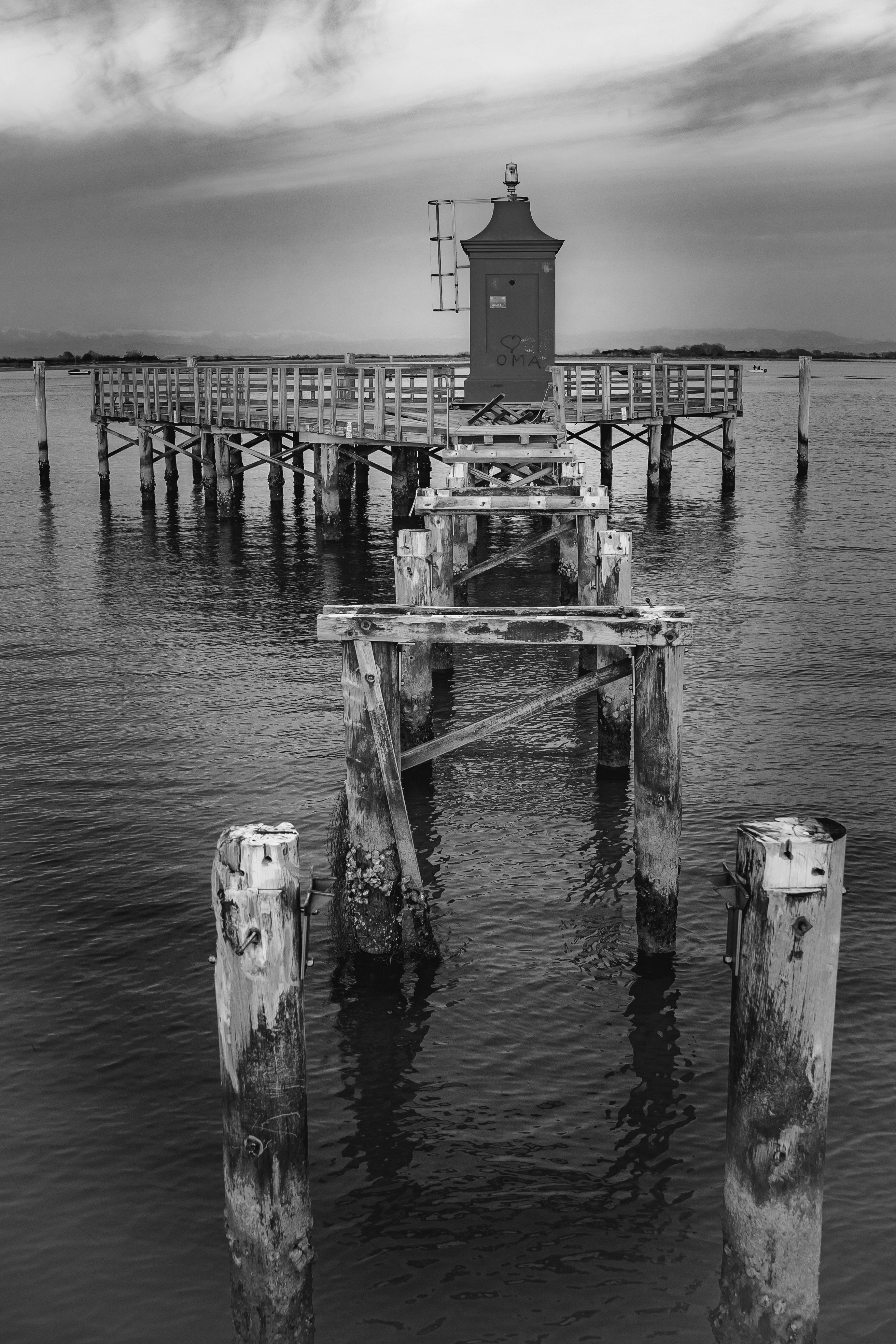 Abandoned Pier Leading to Waterfront Structure · Free Stock Photo
