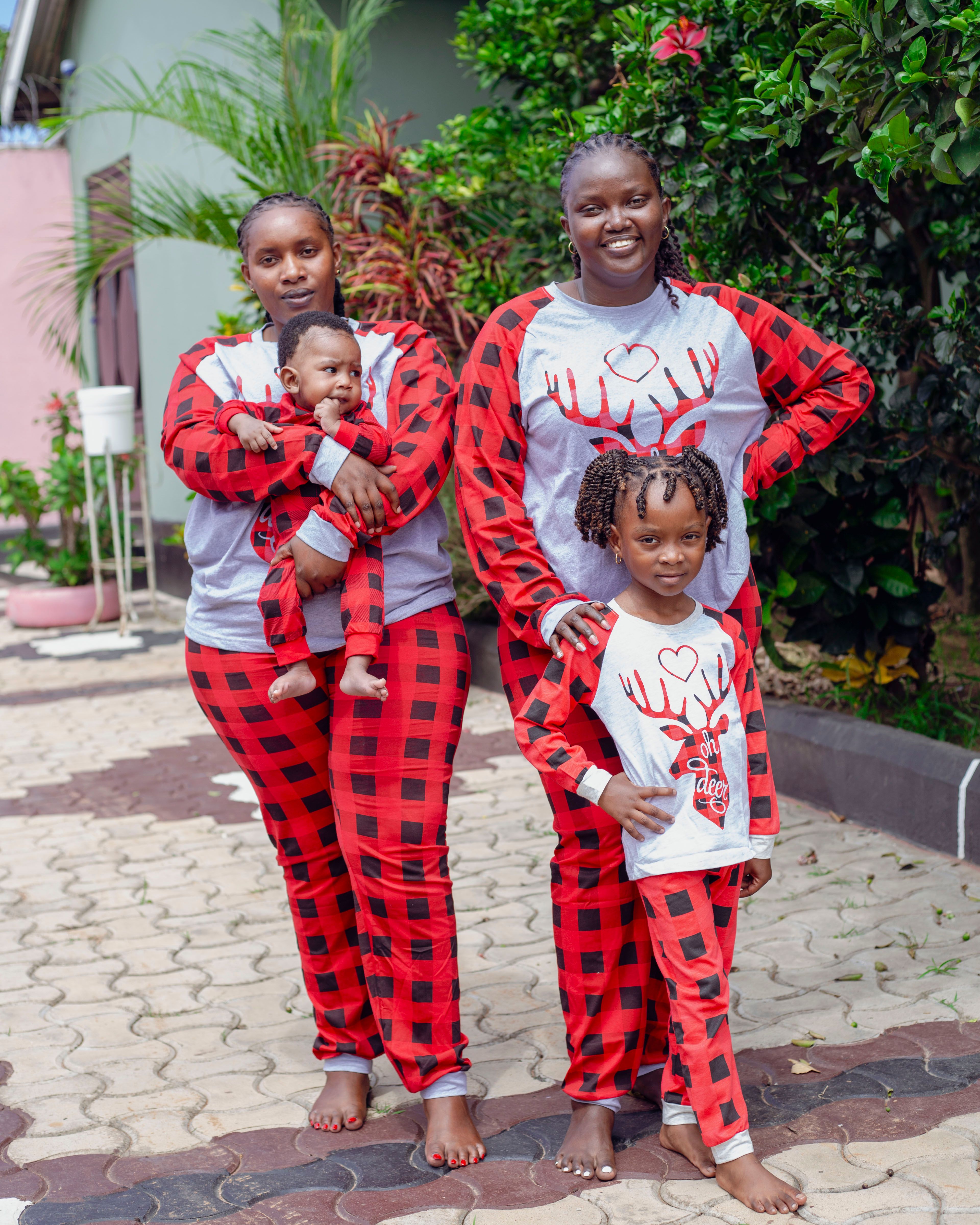 Family in Matching Red Plaid Pajamas Outdoors · Free Stock Photo