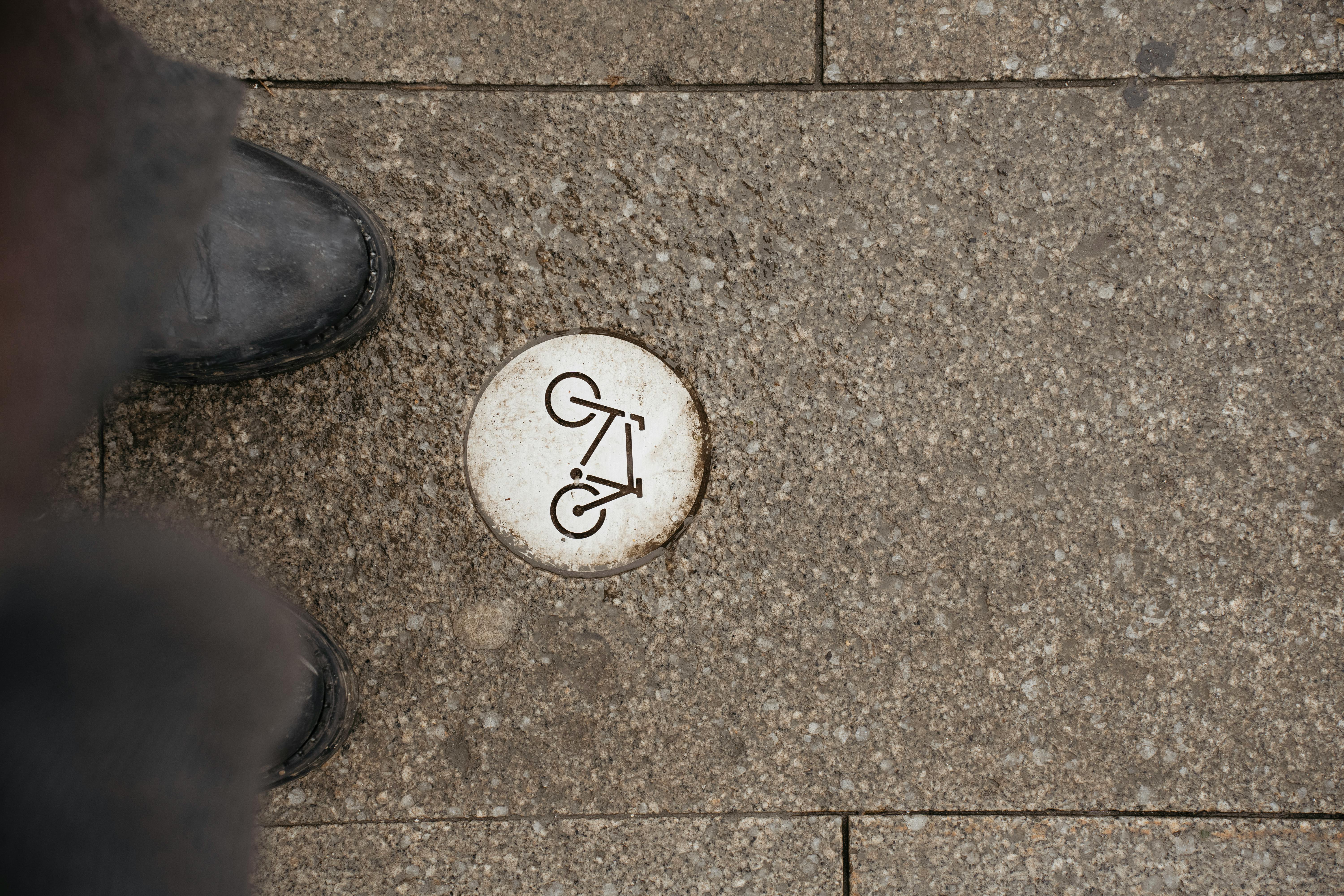 Bicycle Path Marker on Urban Pavement · Free Stock Photo