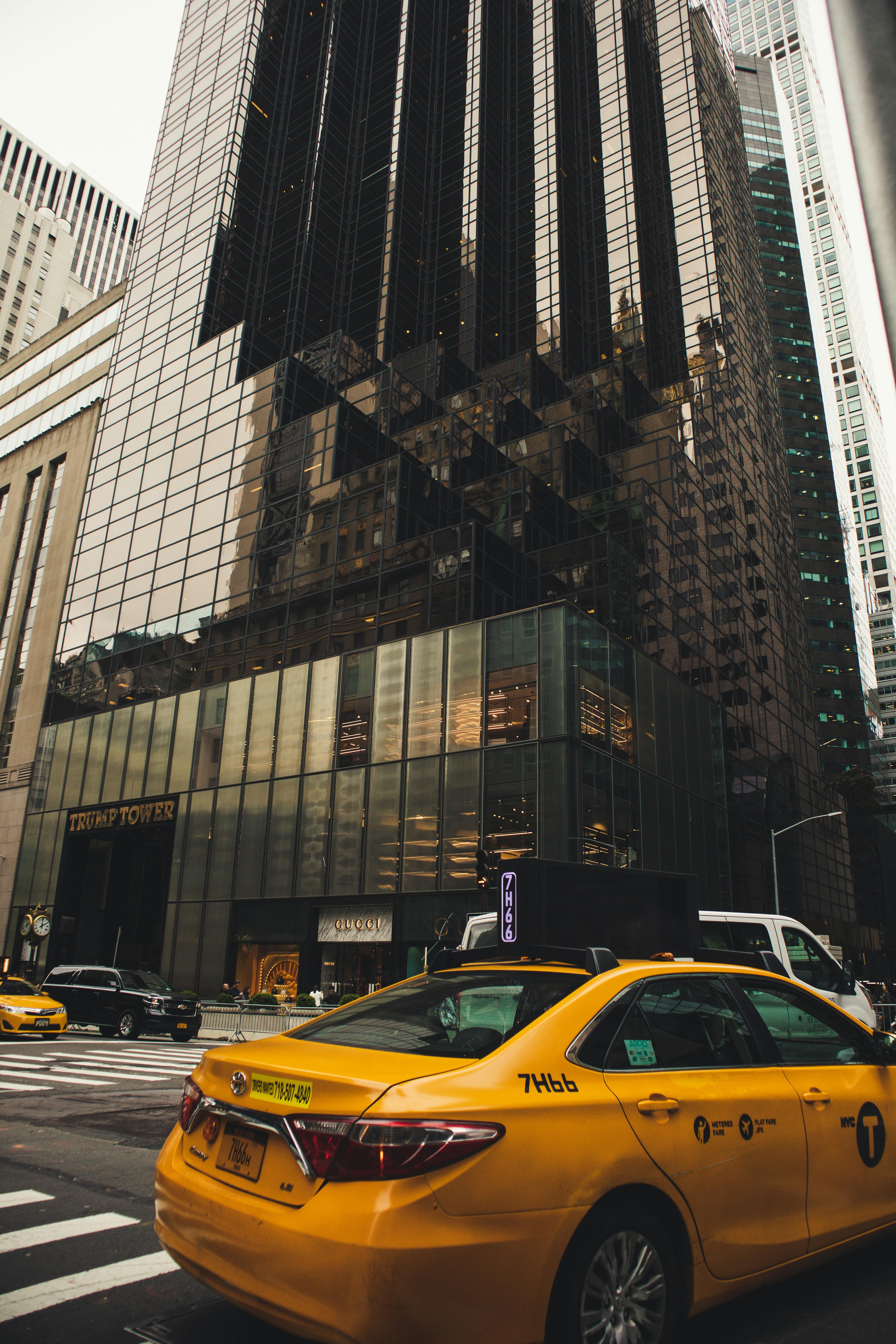New York City Yellow Taxi in Front of Skyscraper · Free Stock Photo