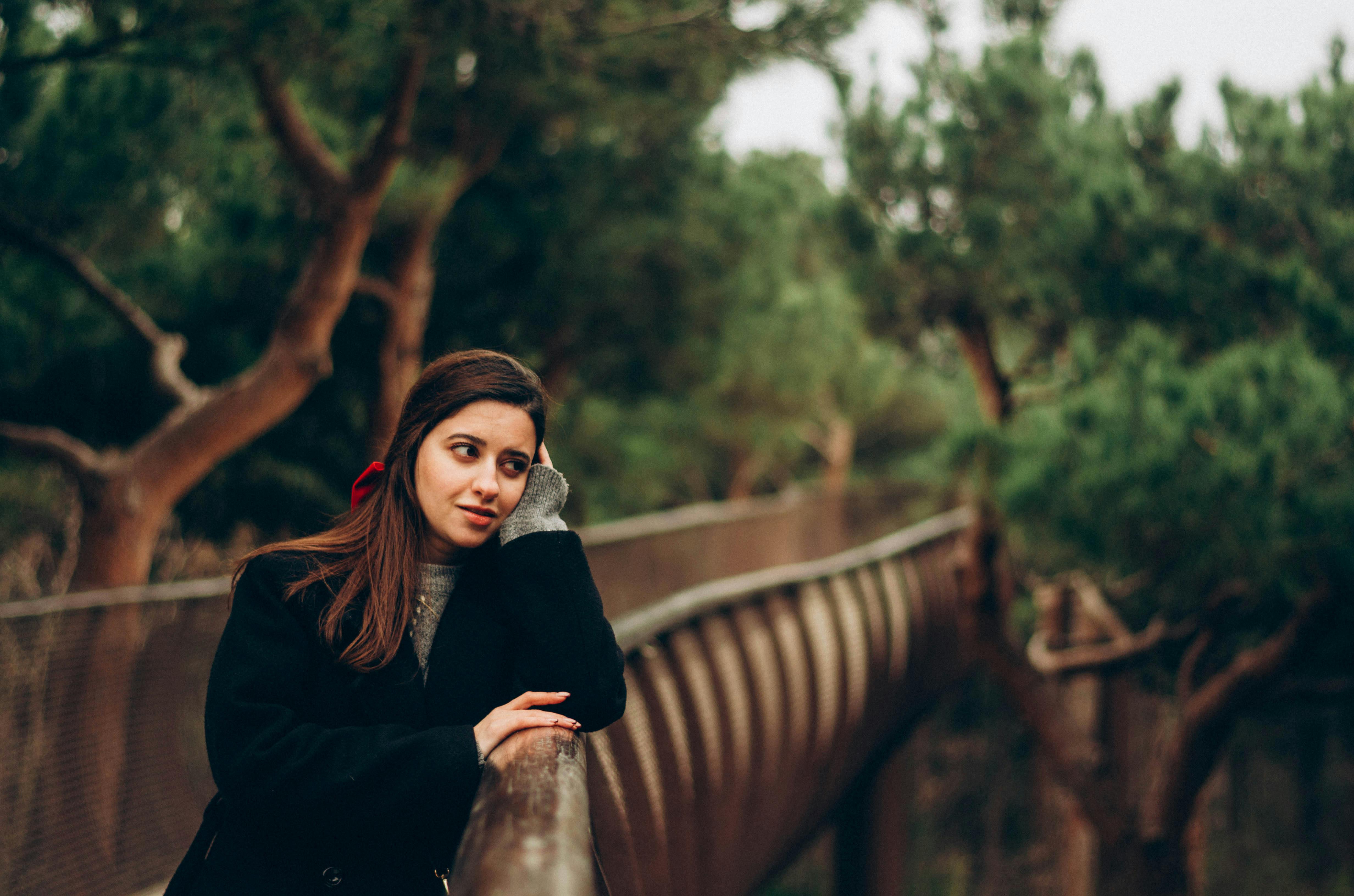 Contemplative Moment on Forest Bridge in Baku · Free Stock Photo