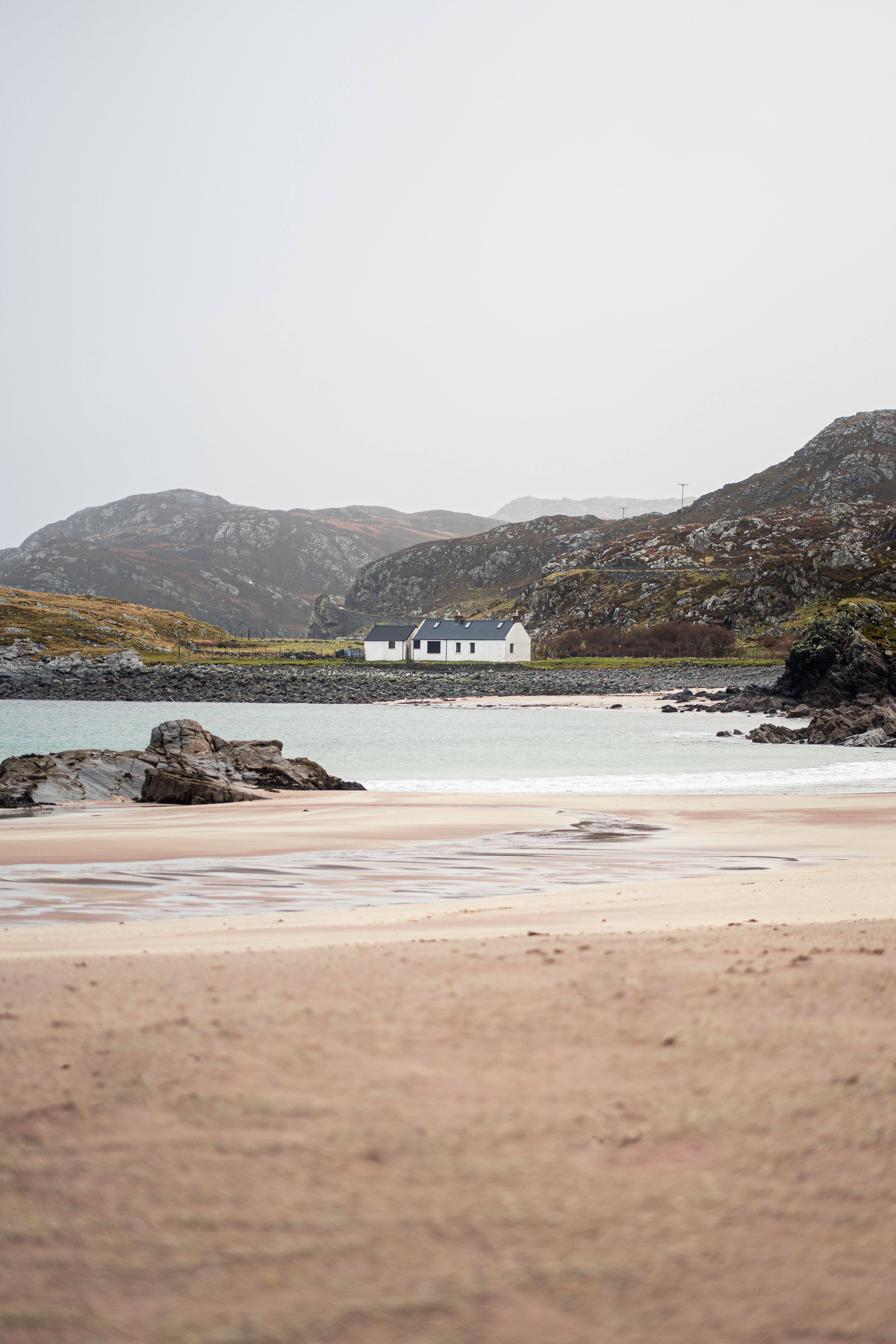 Scenic Coastal View with Remote White Cottage · Free Stock Photo