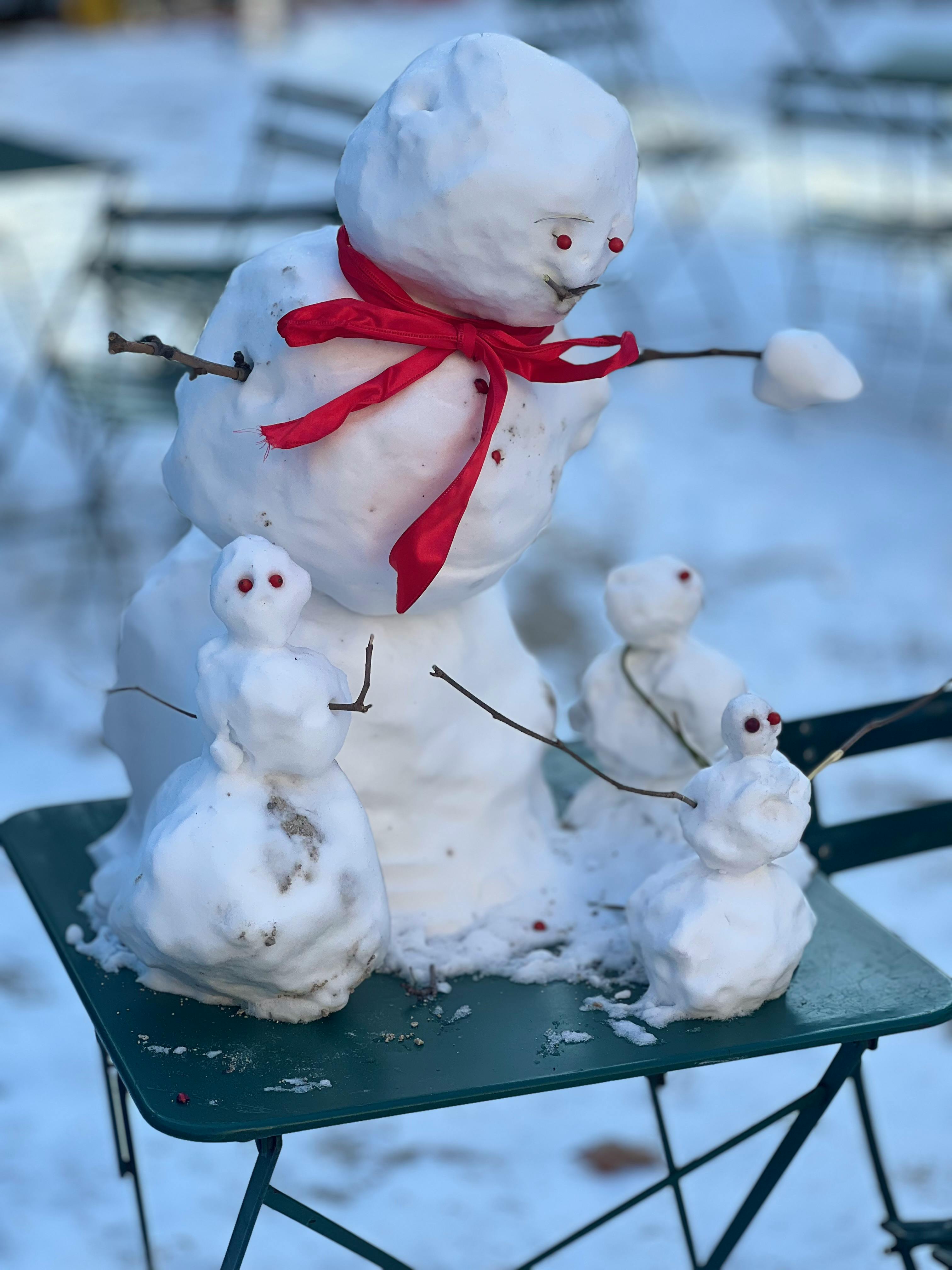 Charming Snowmen Family on Outdoor Table · Free Stock Photo