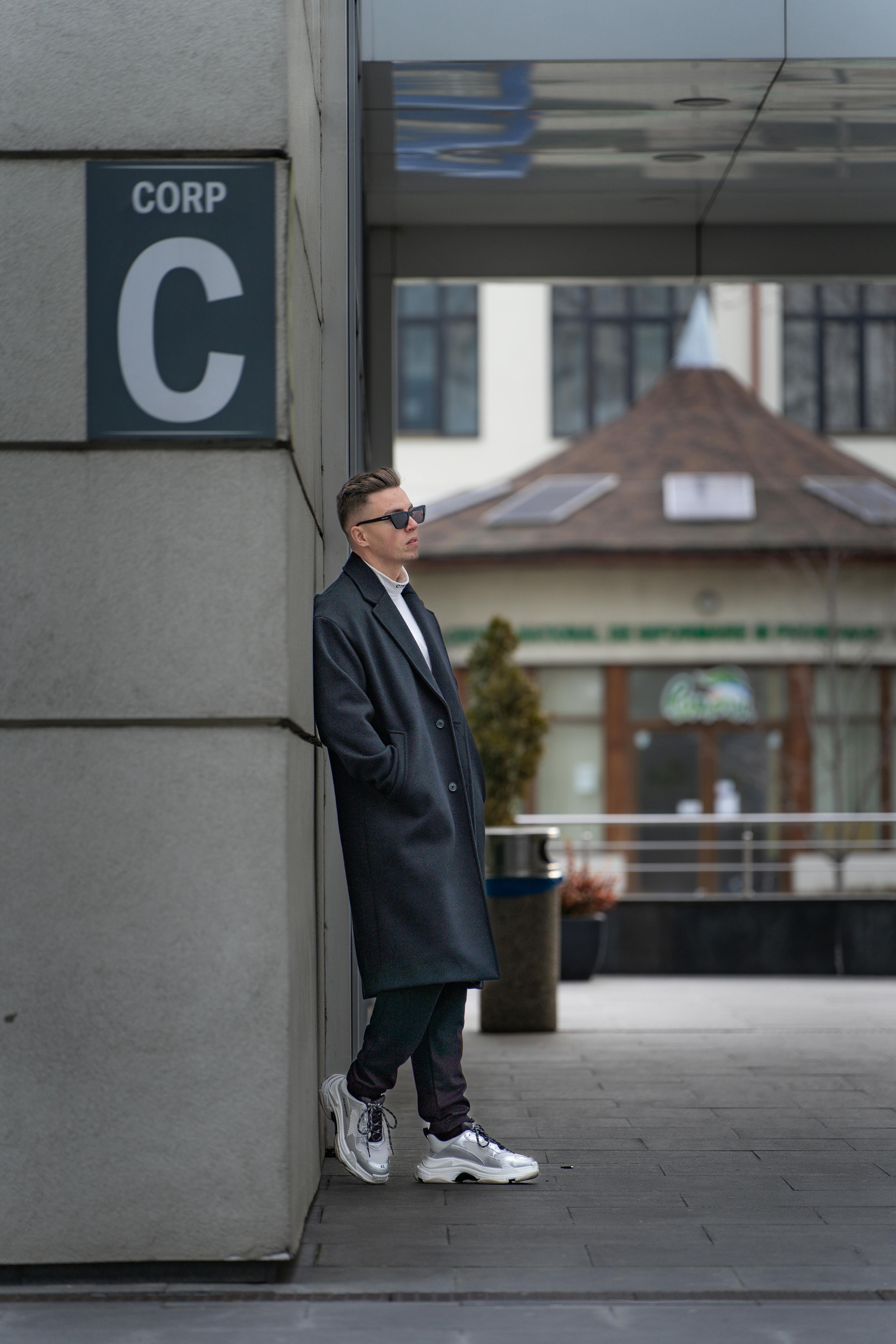 Stylish Man Leaning Against Building in City · Free Stock Photo