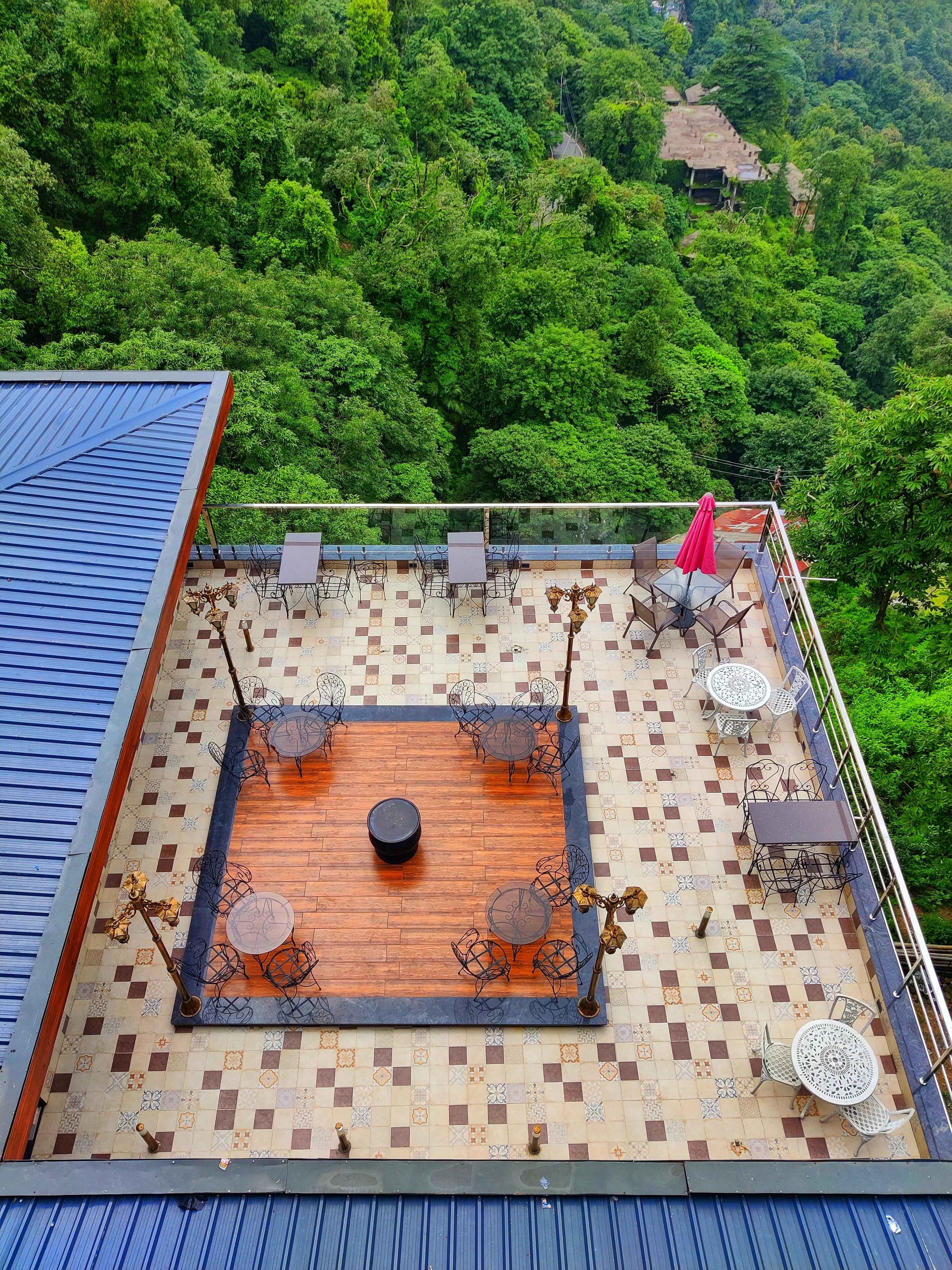 Aerial view of outdoor terrace amidst lush greenery · Free Stock Photo
