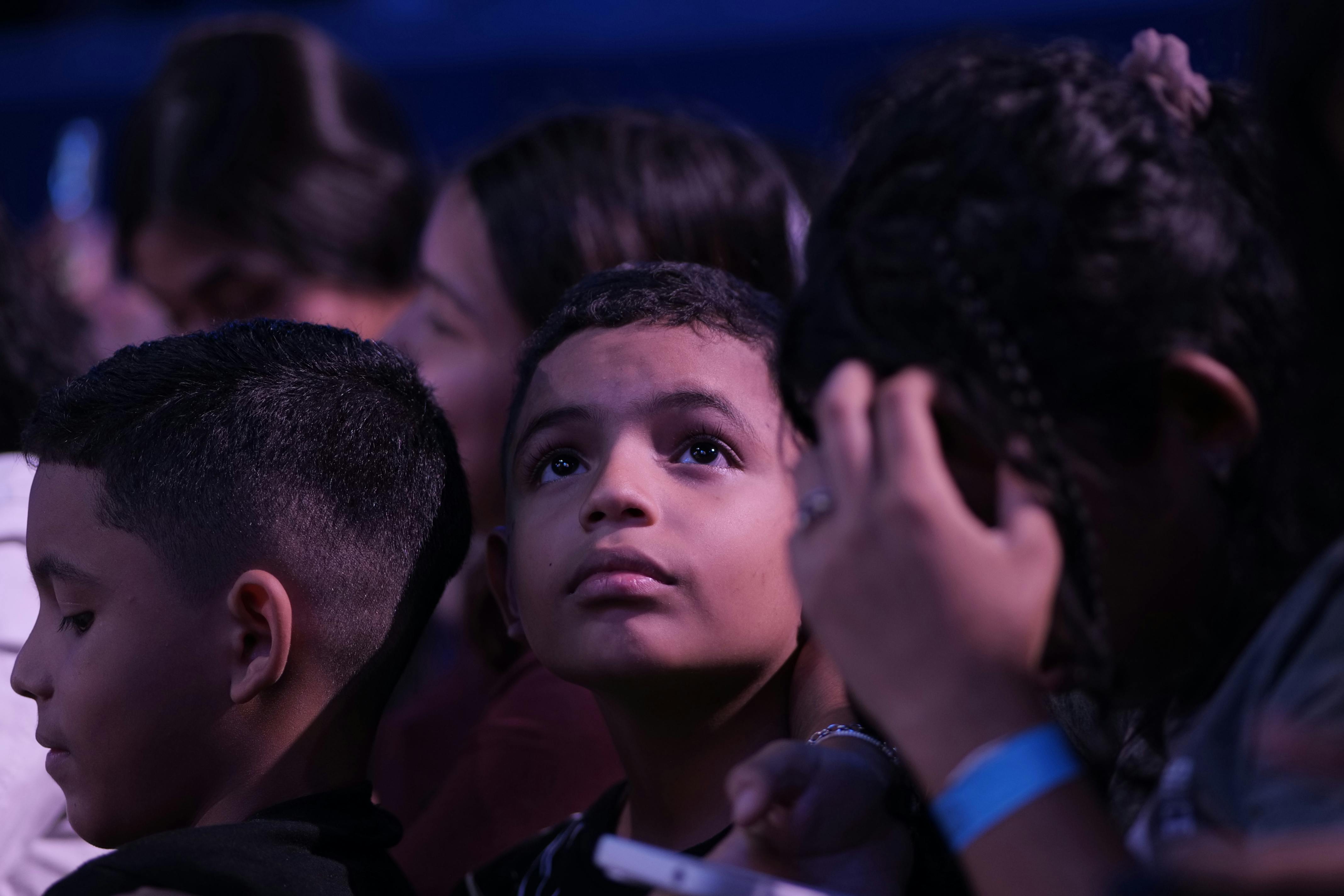 Captivated Children Watching Event Indoors · Free Stock Photo