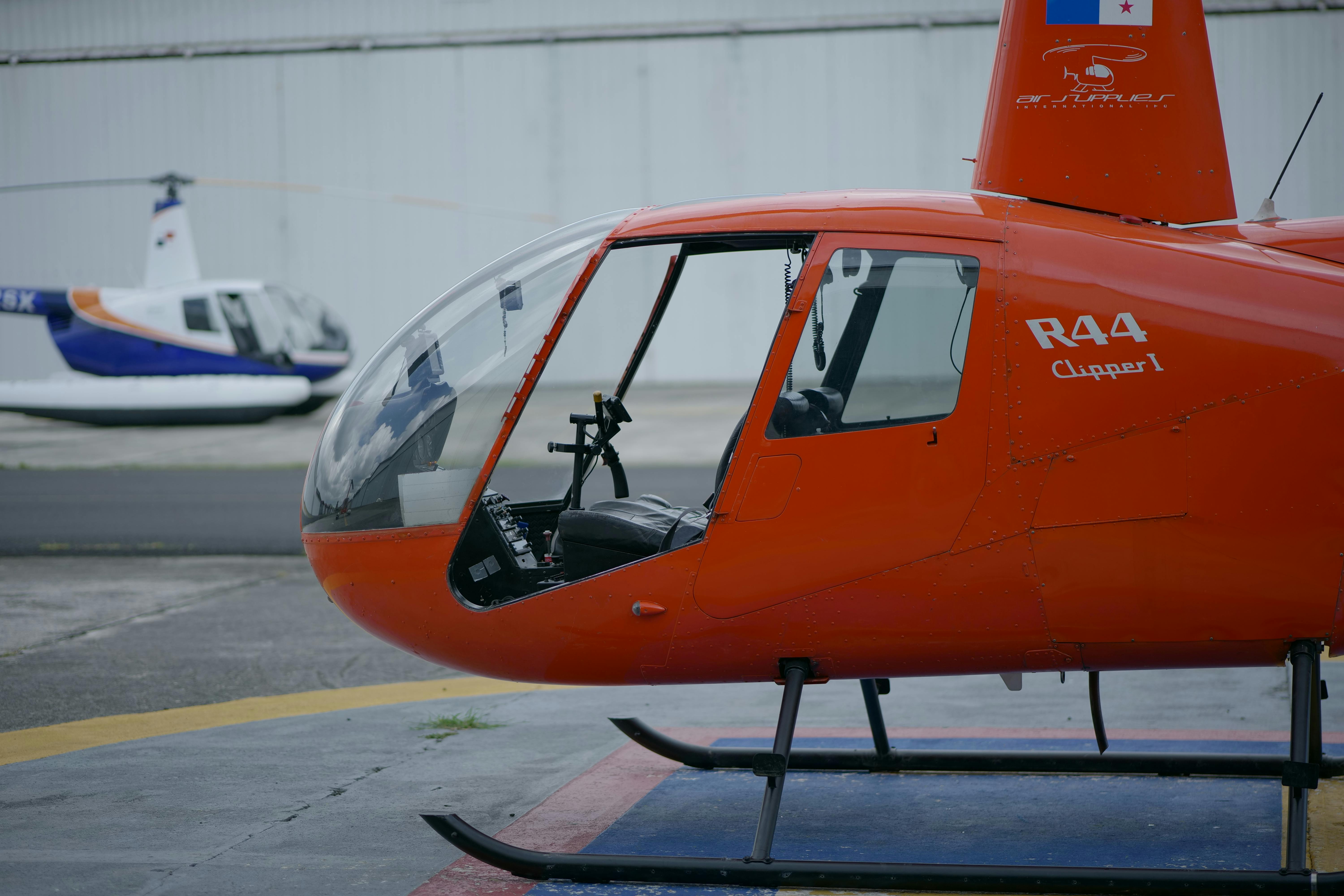 Person Riding White Helicopter · Free Stock Photo