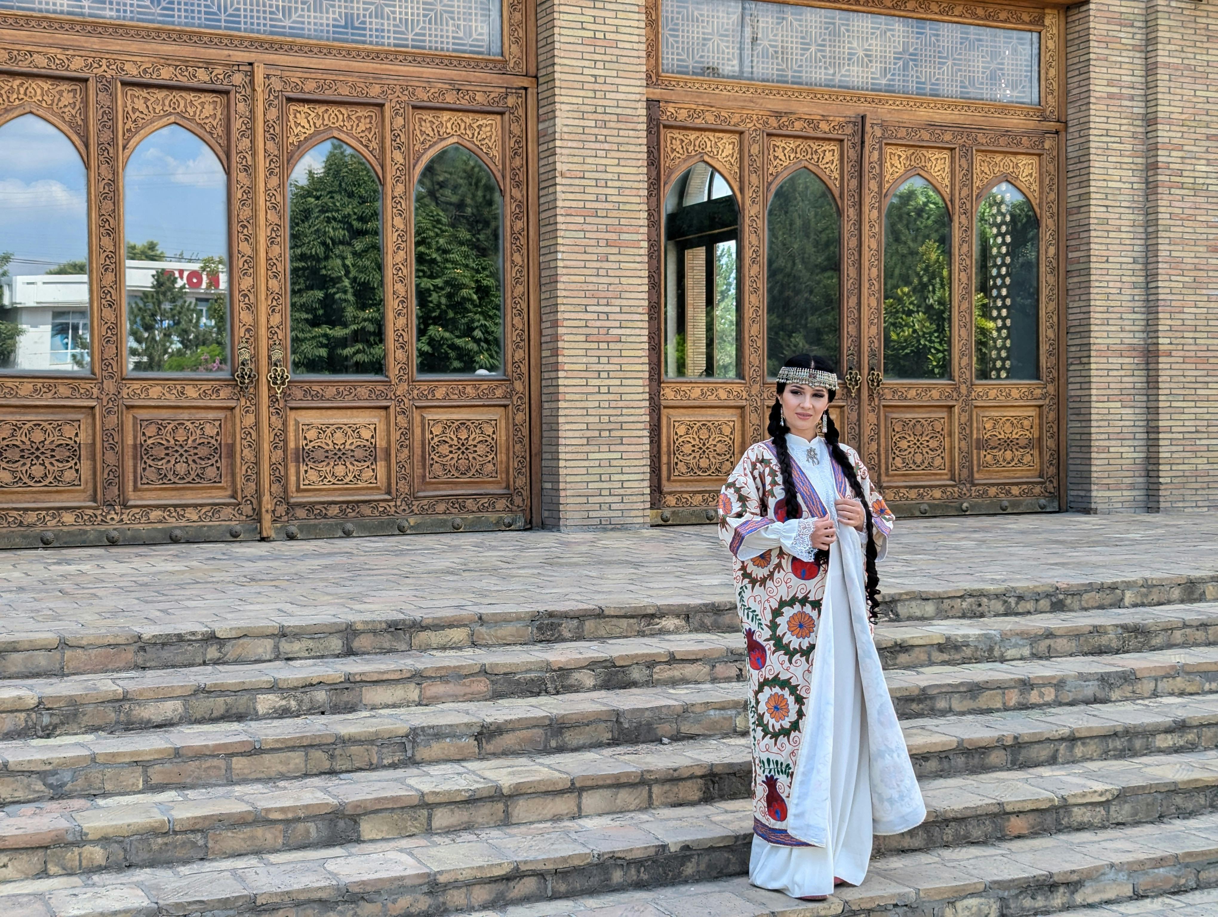 Traditional Uzbek Dress Portrait Outside Ornate Building · Free Stock Photo