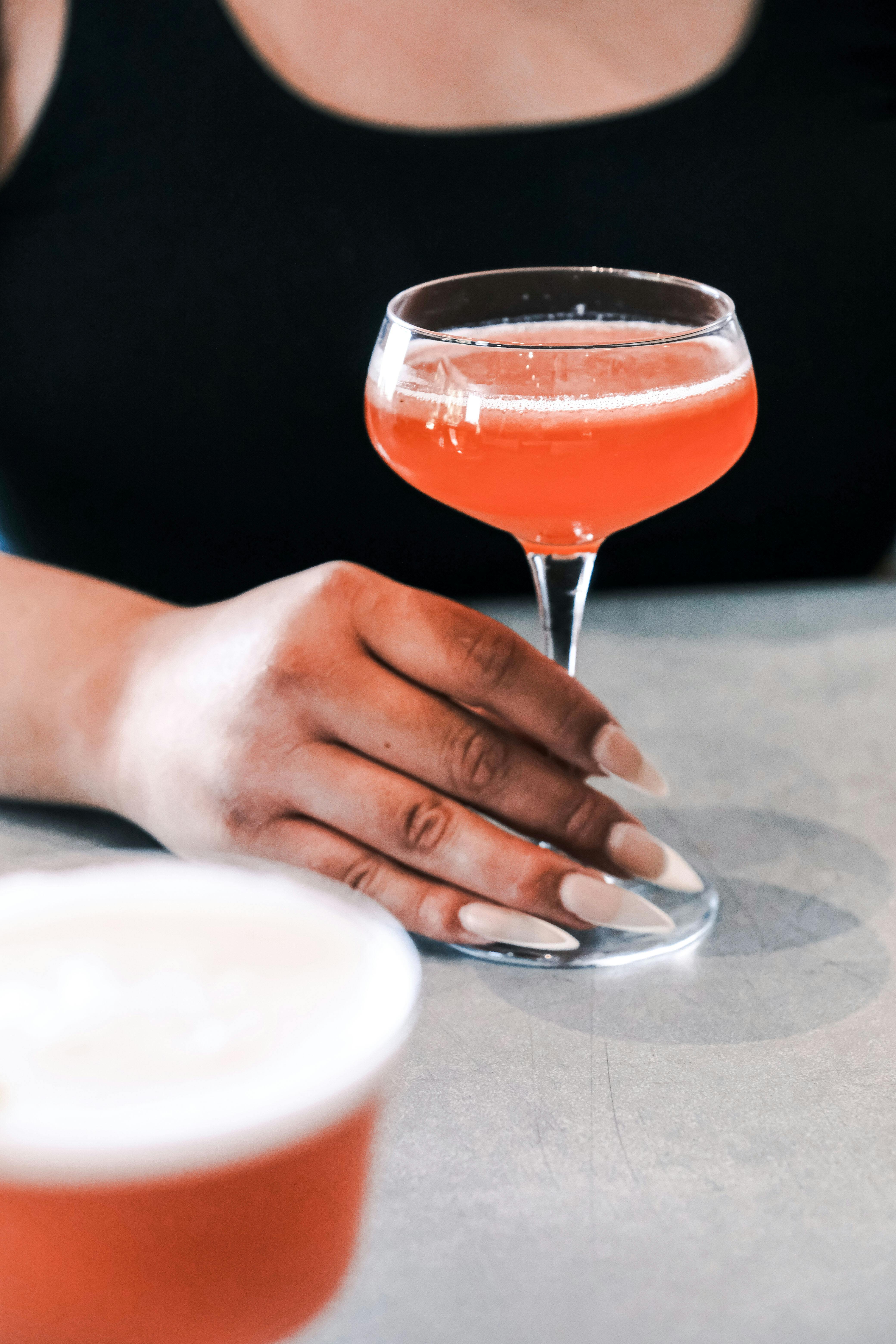 Elegant Female Hand Holding a Fresh Cocktail · Free Stock Photo