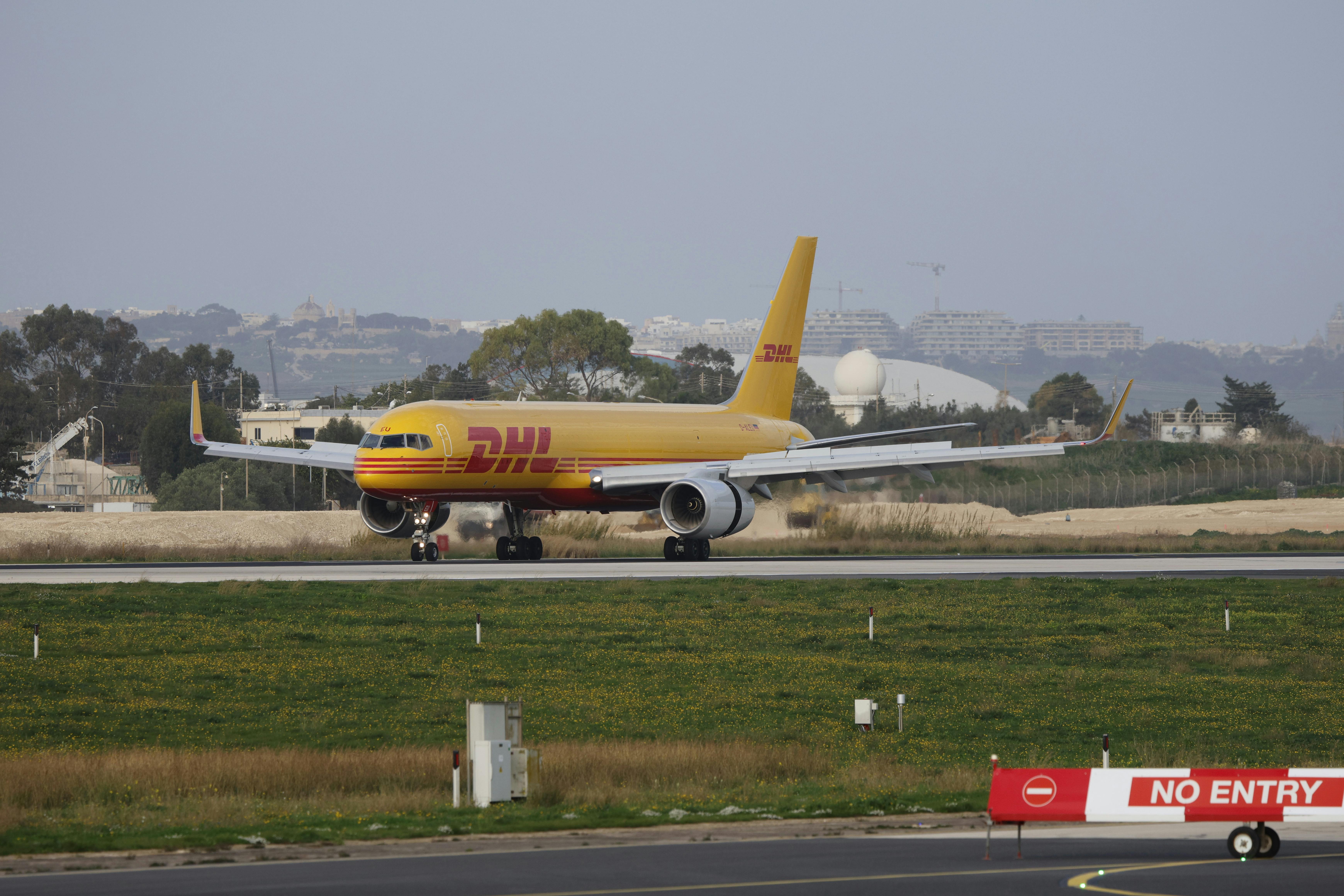 DHL Cargo Plane on Runway at Airport · Free Stock Photo