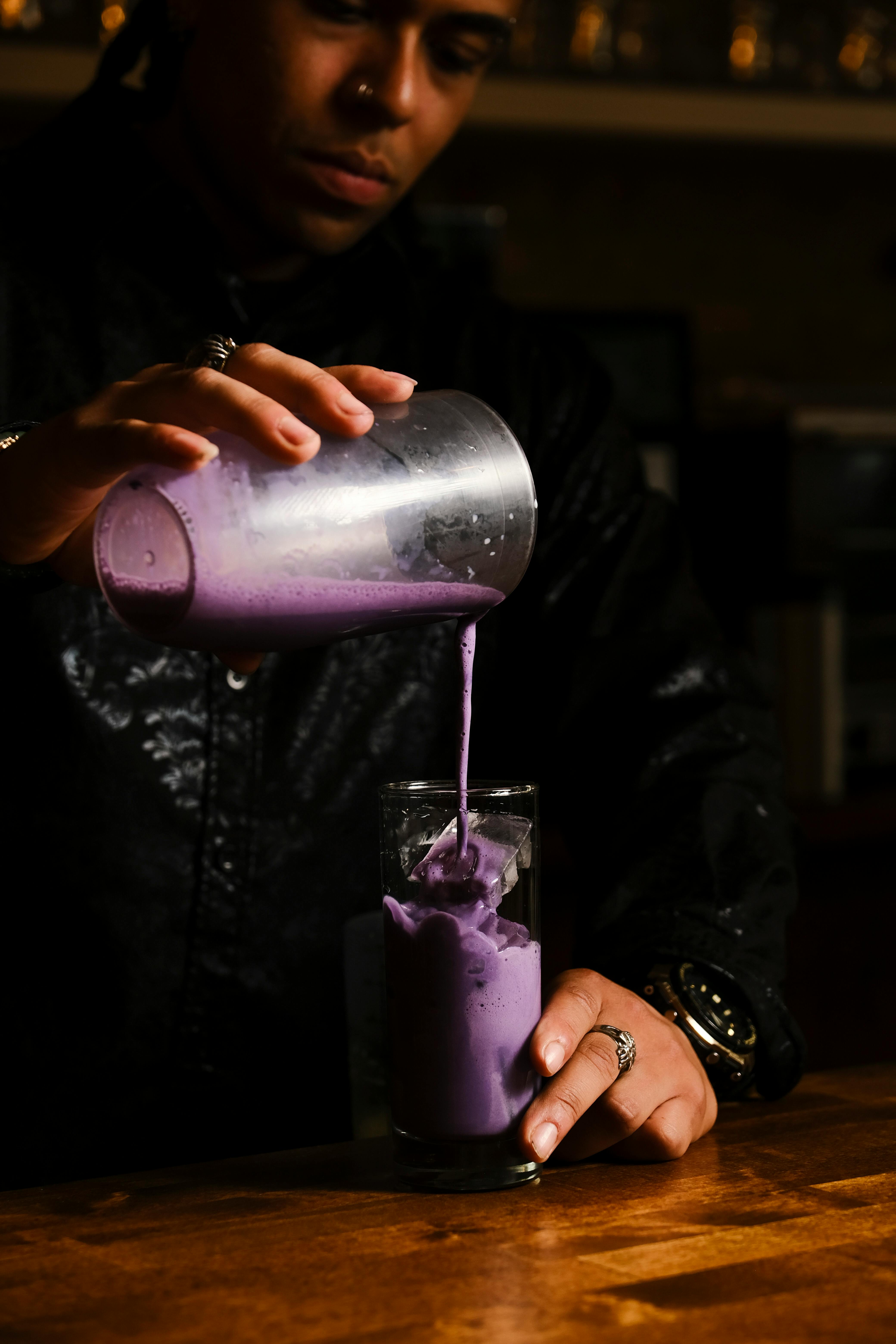 Bartender Crafting a Colorful Purple Cocktail · Free Stock Photo
