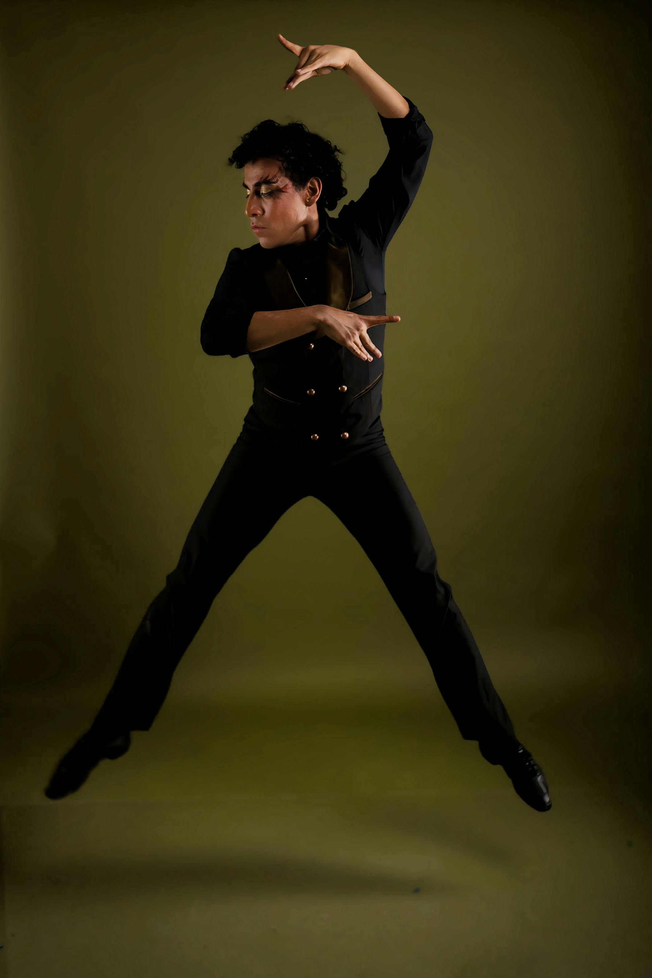 Dynamic Jumping Pose of a Stylish Performer · Free Stock Photo