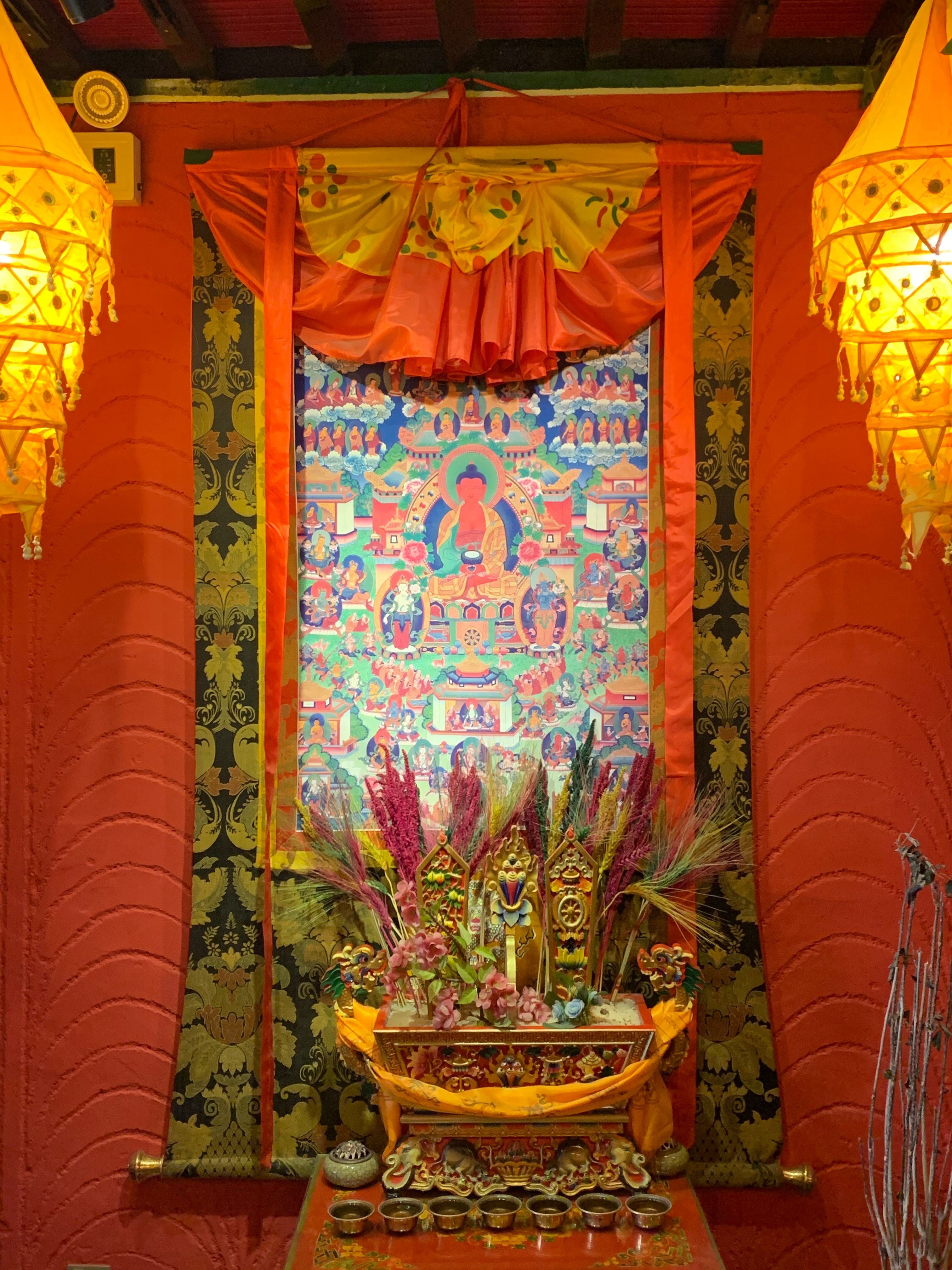 Colorful Buddhist Altar with Tapestry and Offerings · Free Stock Photo