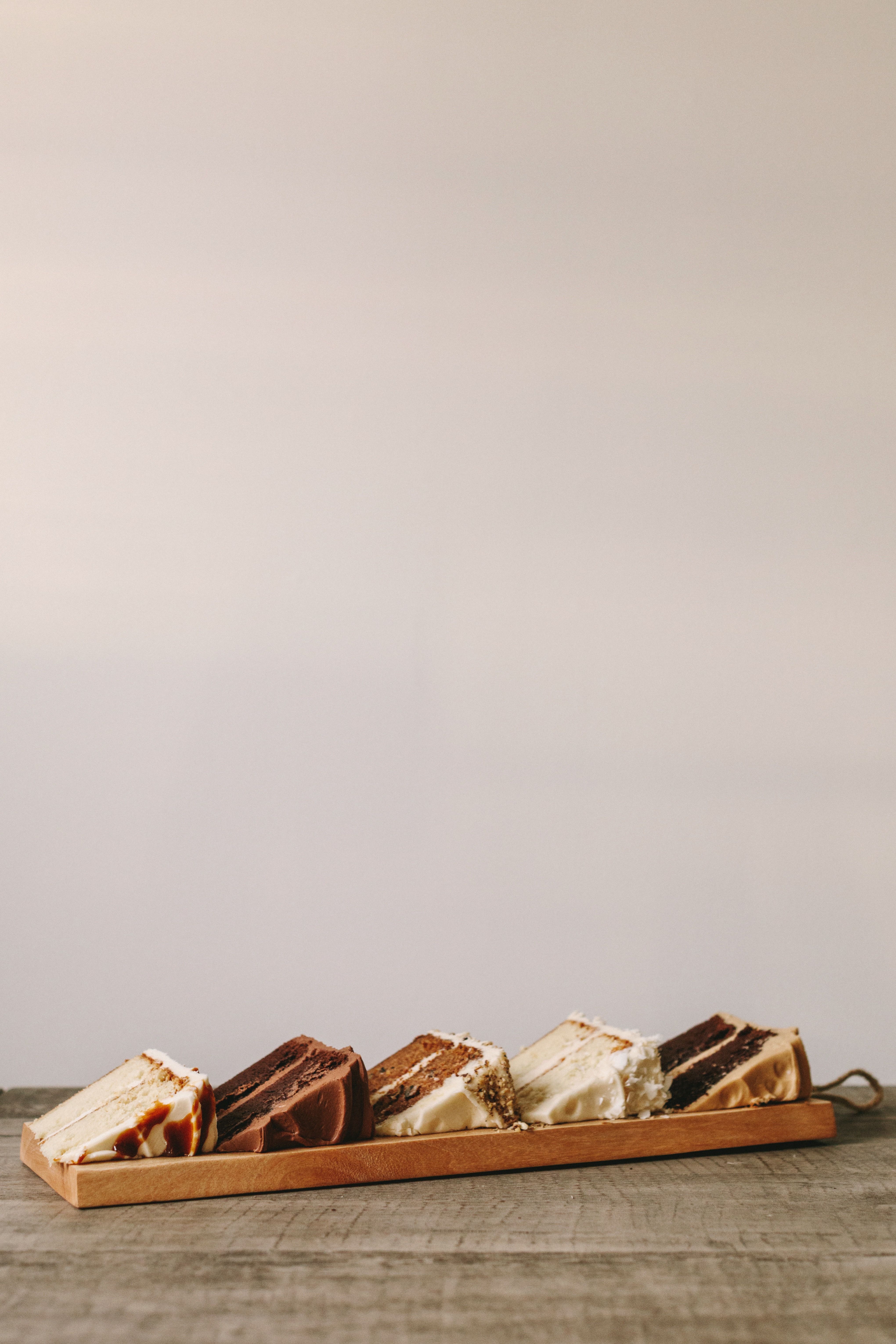 Assorted Artisan Cake Slices on Wooden Tray · Free Stock Photo
