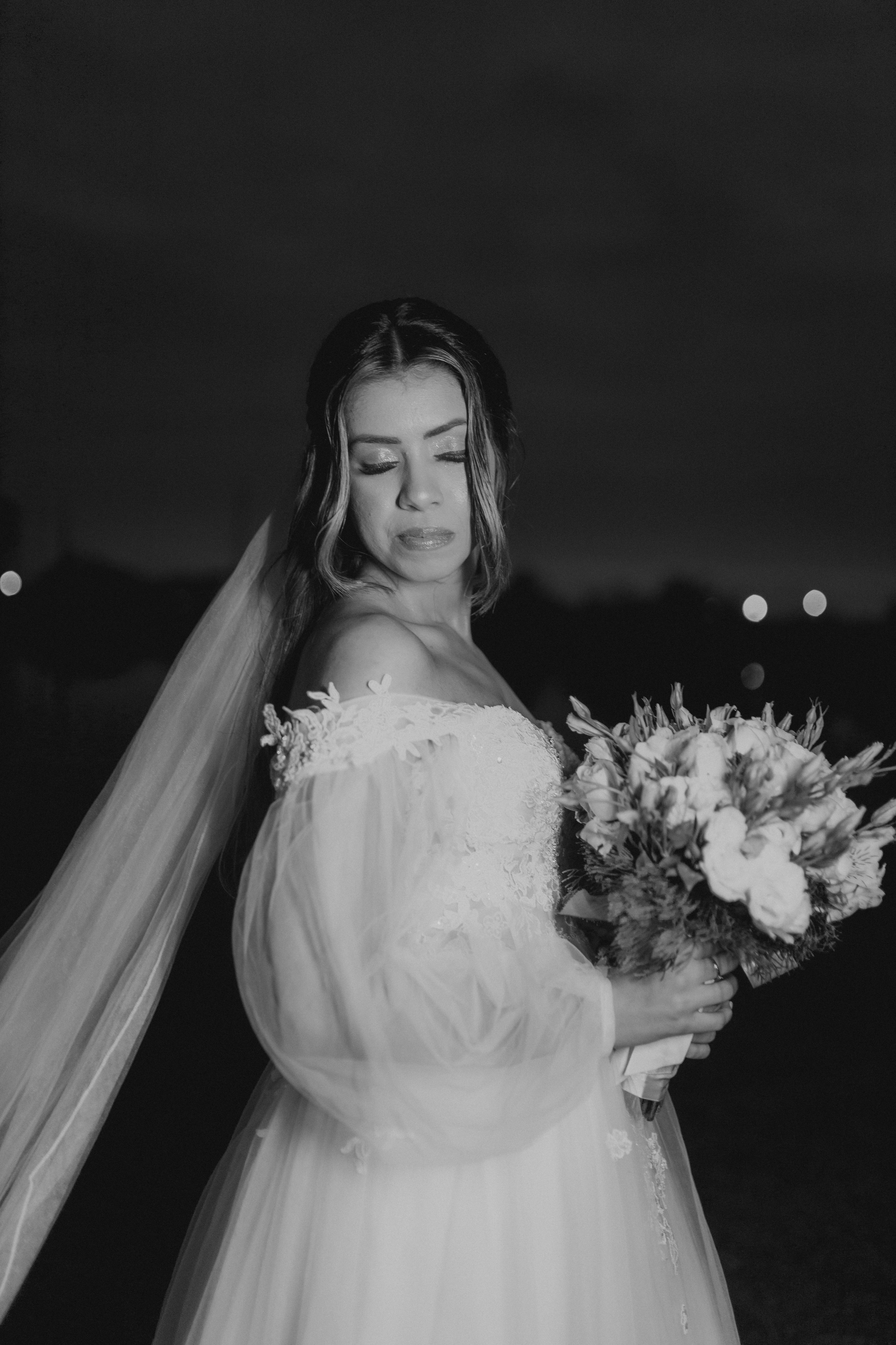 Elegantly Posed Bride Holding Bouquet at Night · Free Stock Photo