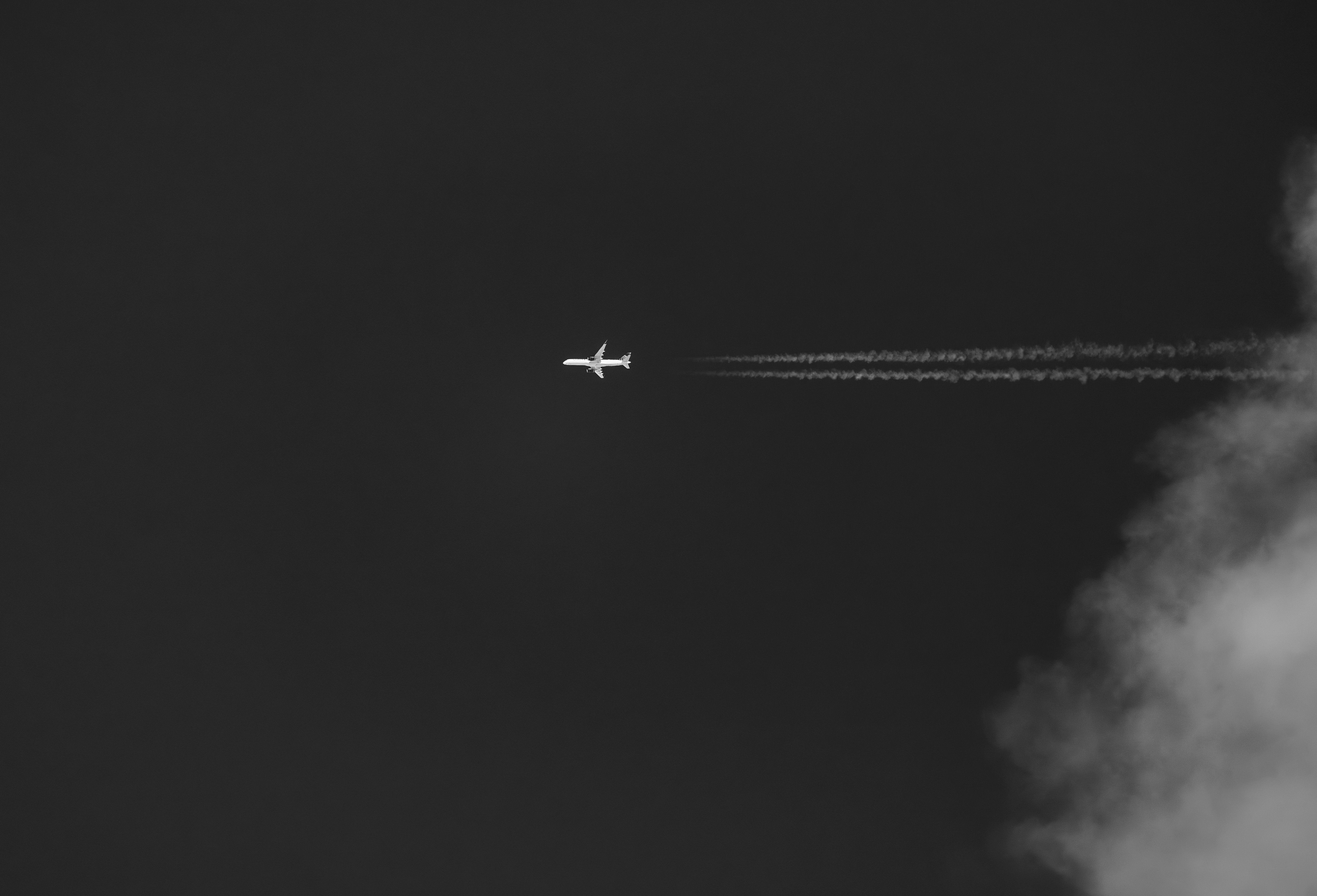 High-Altitude Jet with Contrail in Sky · Free Stock Photo