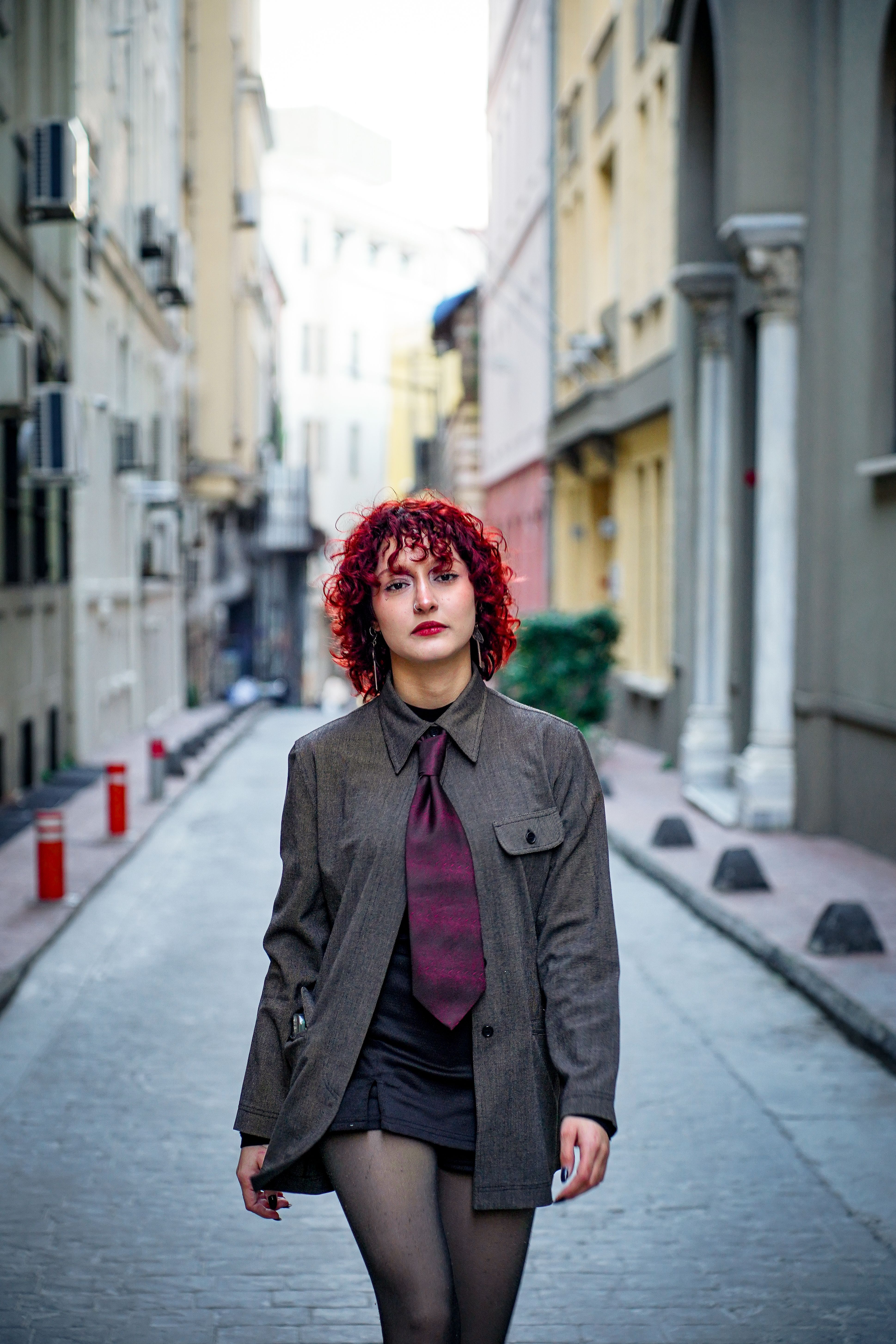 Stylish Woman Walking in Urban Street Setting · Free Stock Photo
