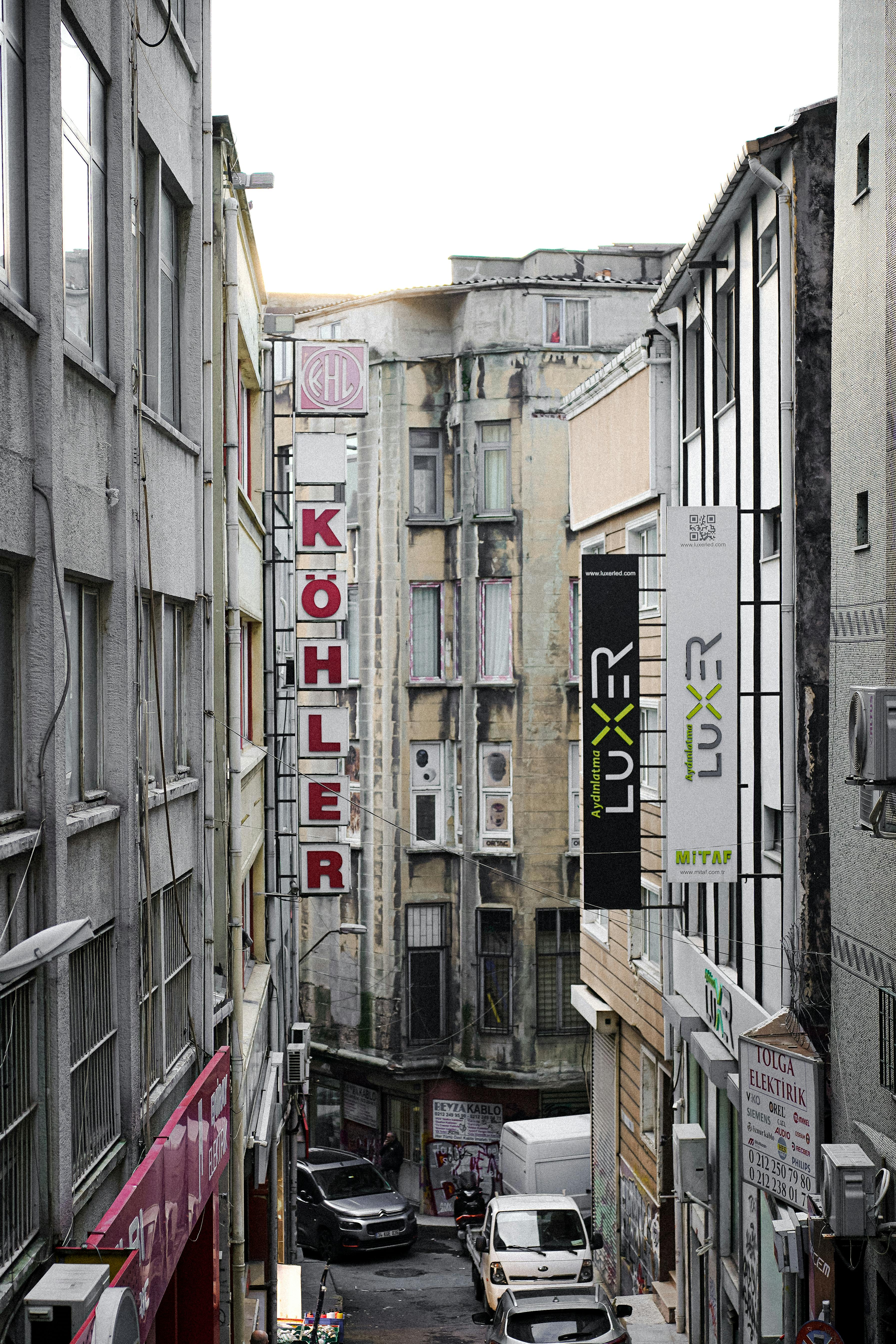 Narrow Urban Alley with Commercial Signs · Free Stock Photo