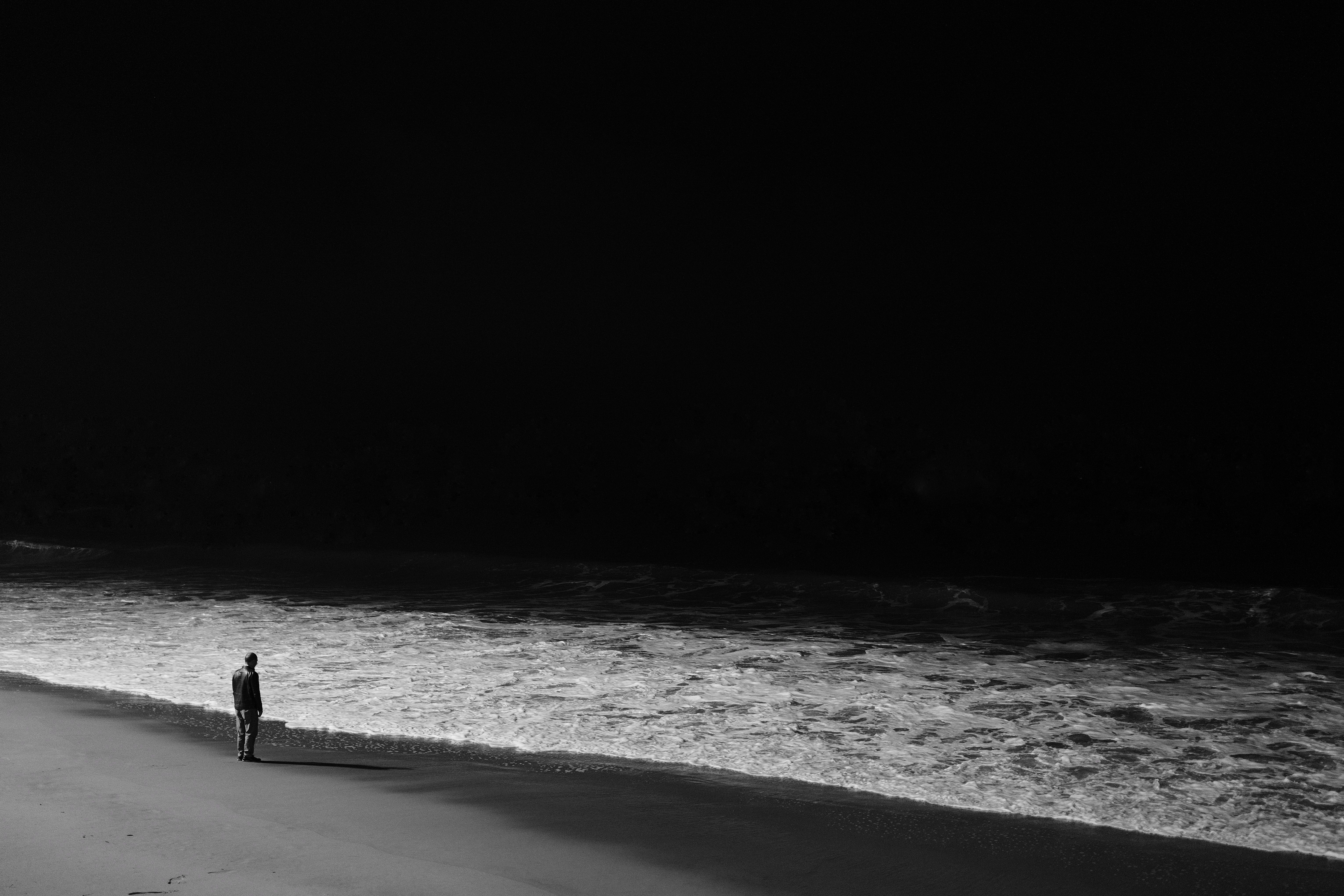 Solitary Figure on the Shore at Night · Free Stock Photo