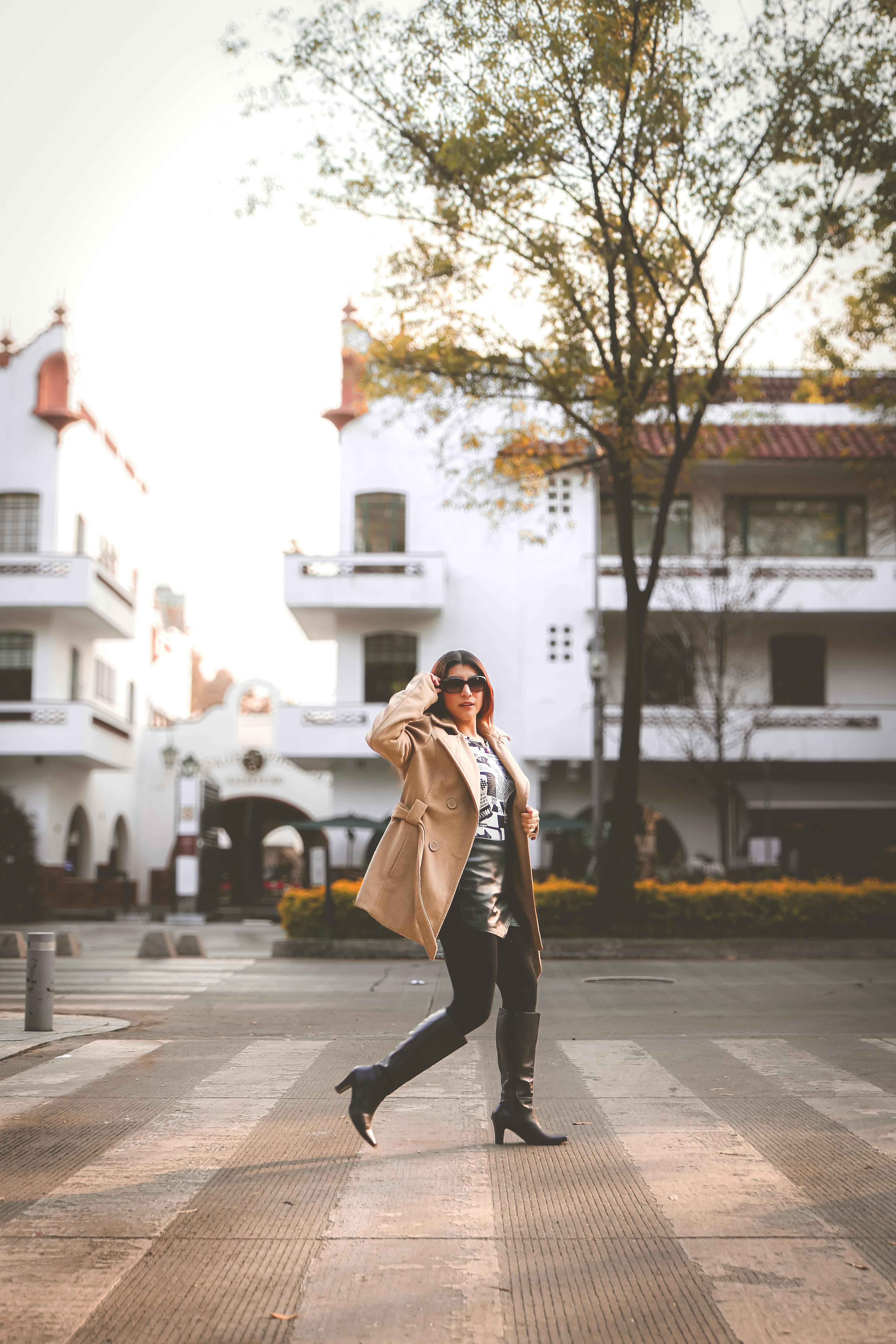 Stylish Woman Walking in Urban Setting · Free Stock Photo