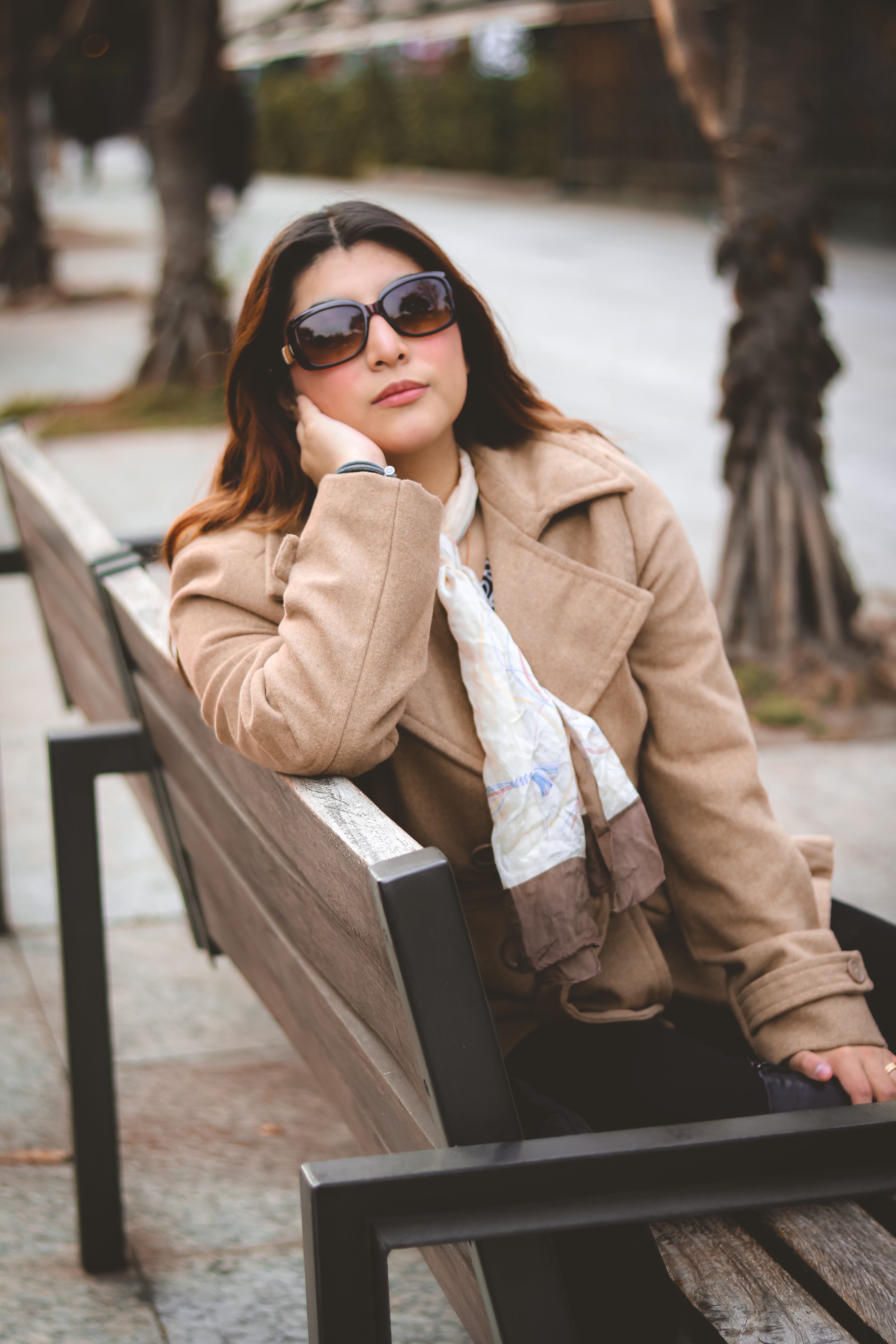 Woman Relaxing on Park Bench in Autumn Sun · Free Stock Photo