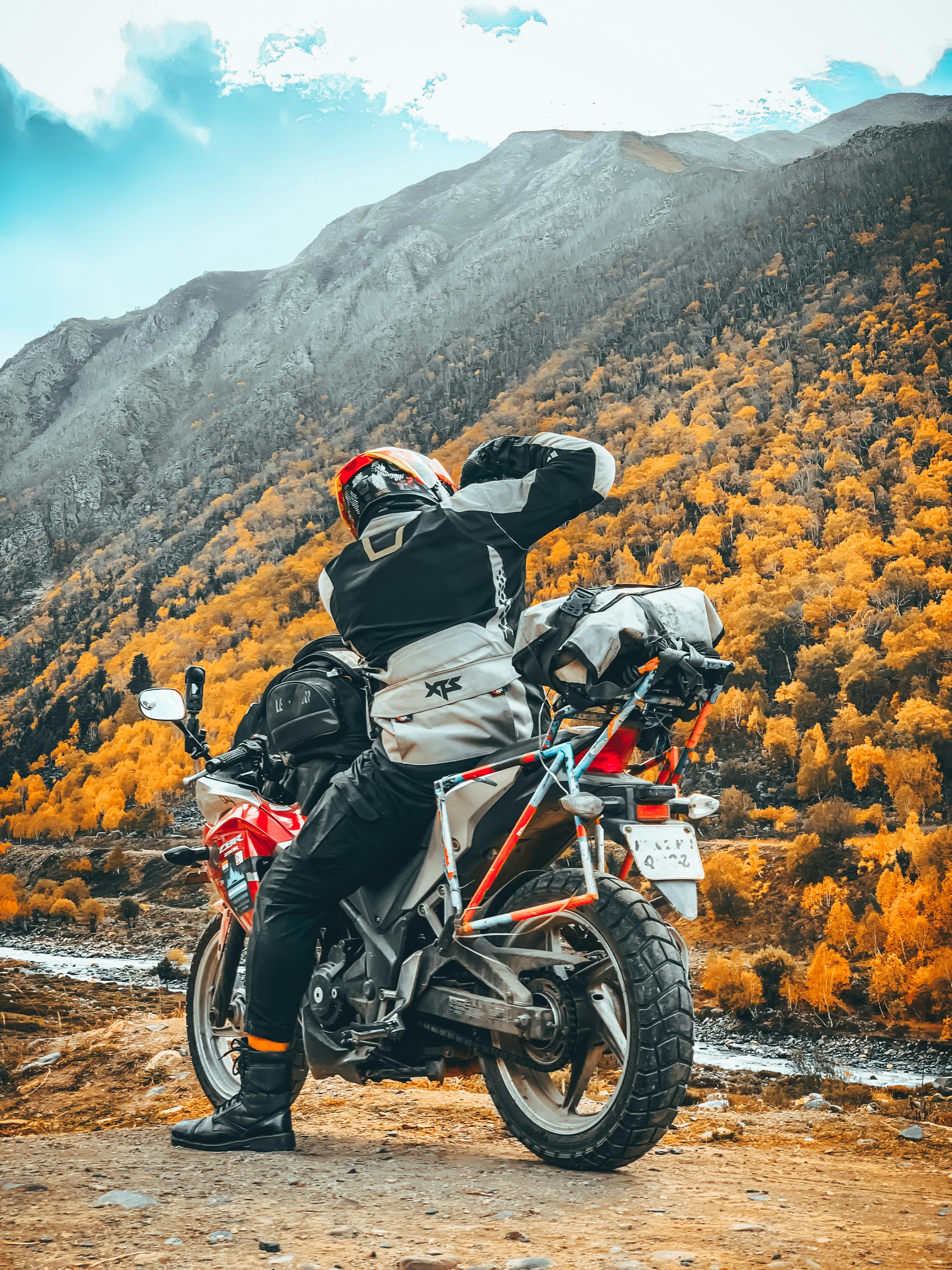 Biker Exploring Autumn Mountain Landscape · Free Stock Photo