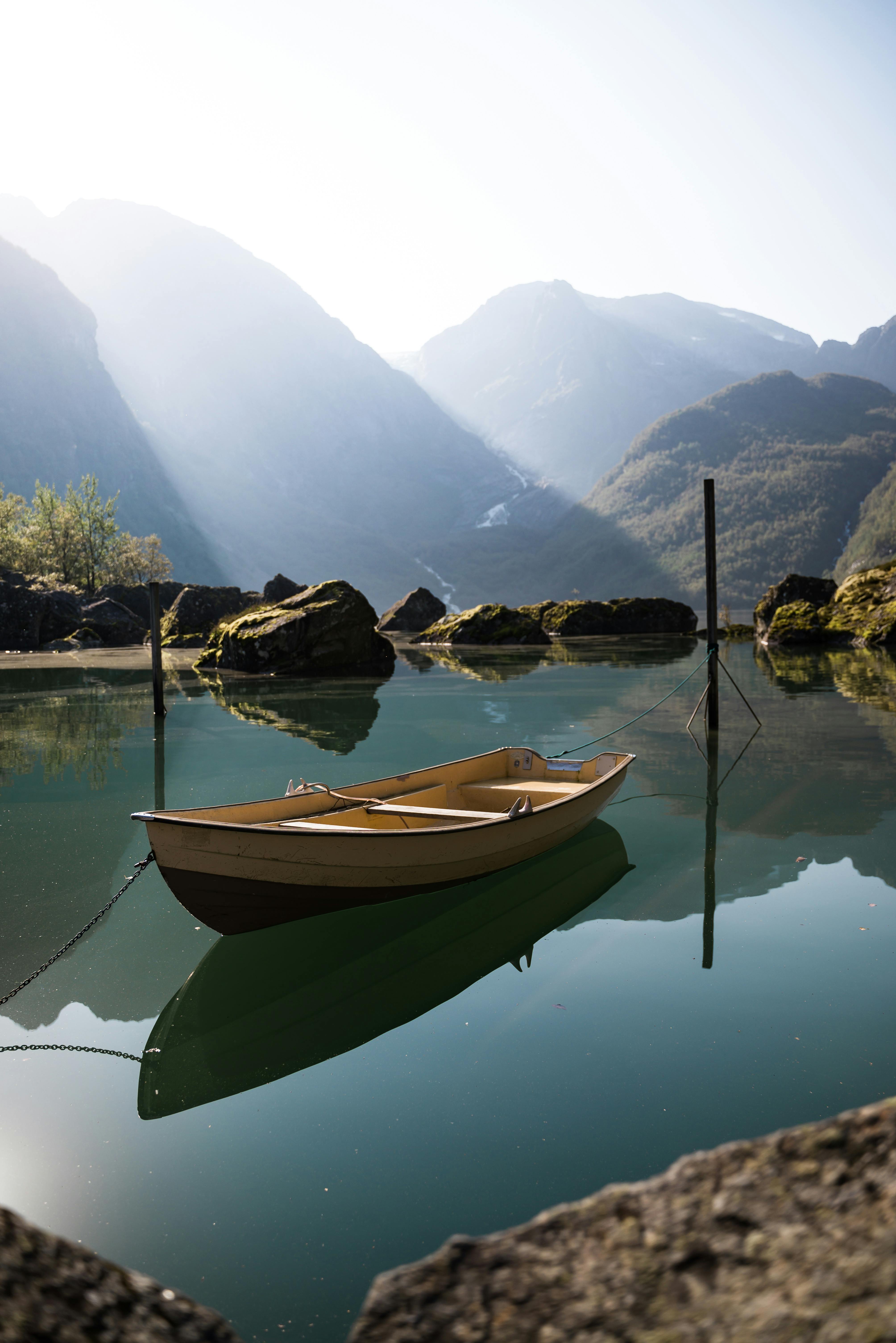 Tranquil Norwegian Fjord with Empty Rowboat · Free Stock Photo