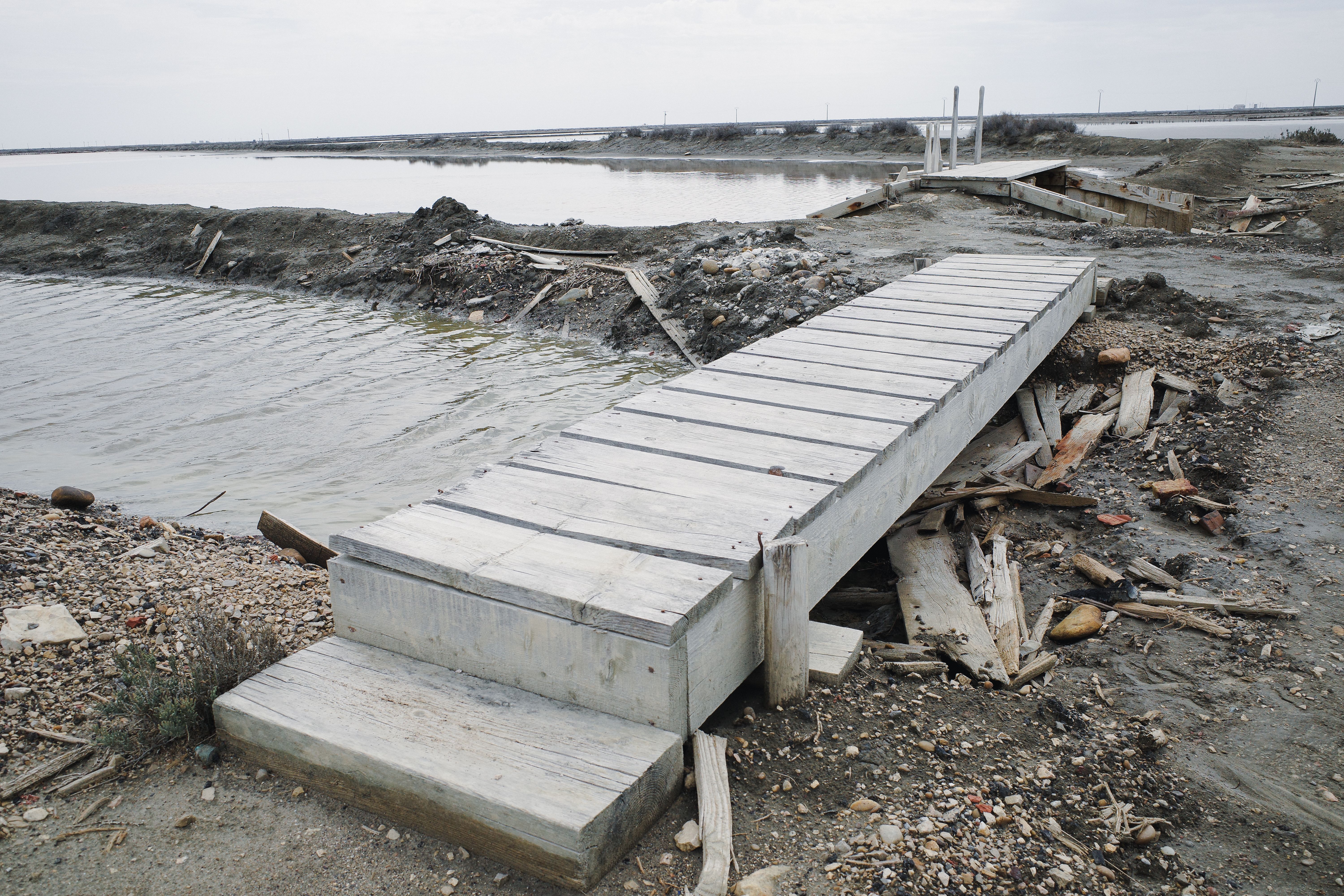 Abandoned Wooden Bridge over Rough Waterscape · Free Stock Photo