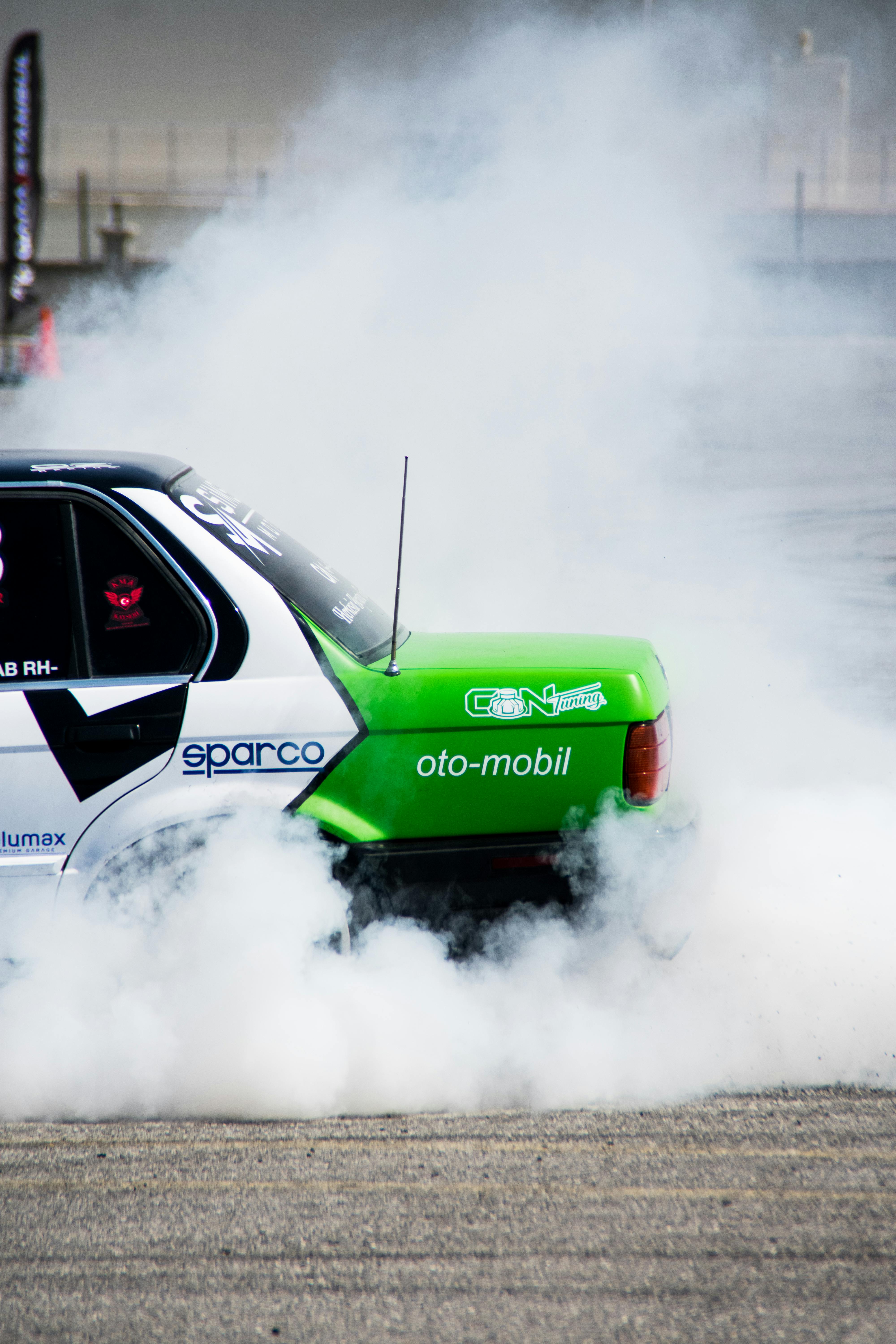 High-Octane Racing Car Performing Tire Burnout · Free Stock Photo