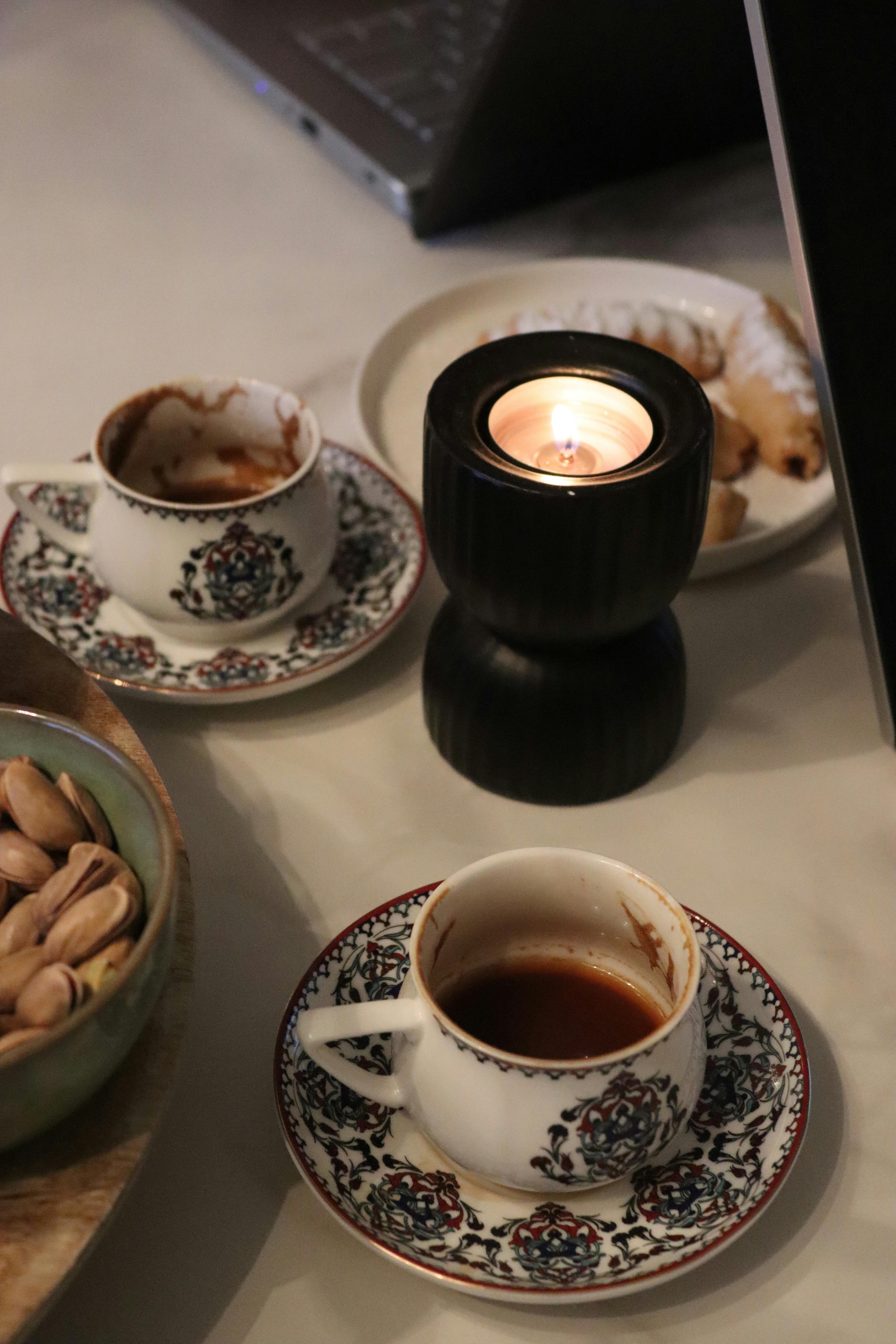 Elegant Coffee Setting with Candlelight Ambiance · Free Stock Photo