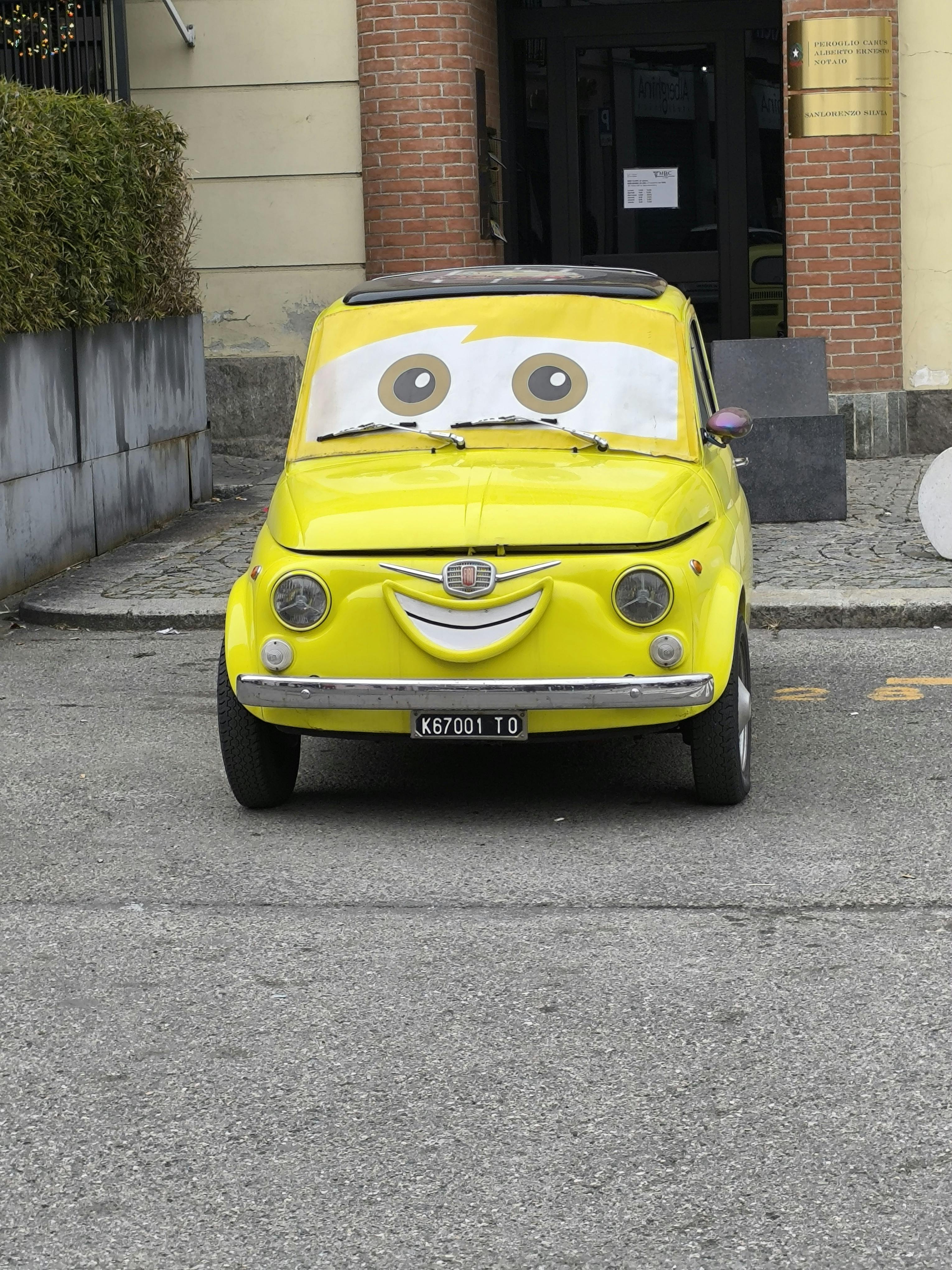 Bright Yellow Car with Cartoon Face · Free Stock Photo