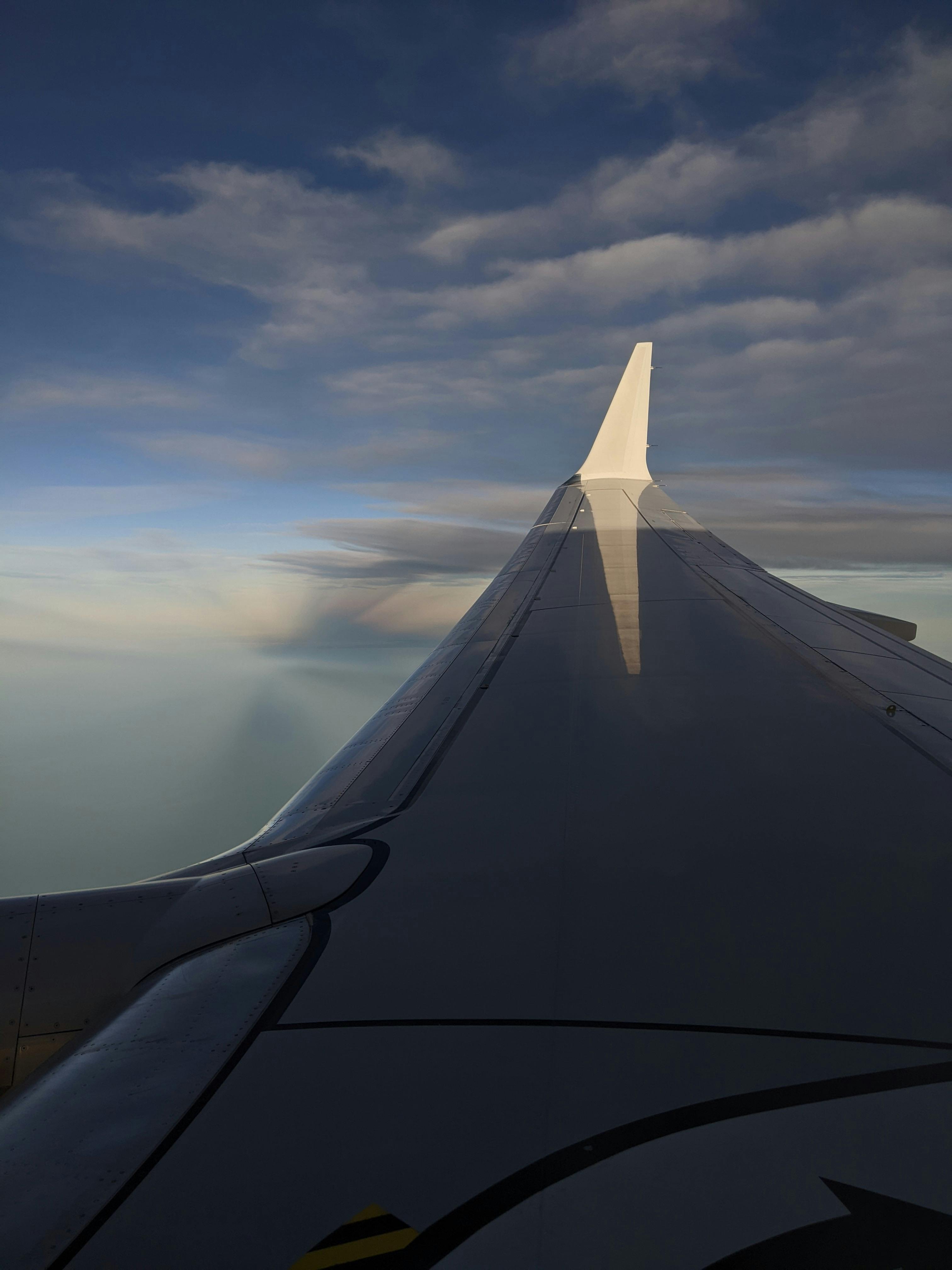 Scenic Airplane Wing View Above Clouds · Free Stock Photo