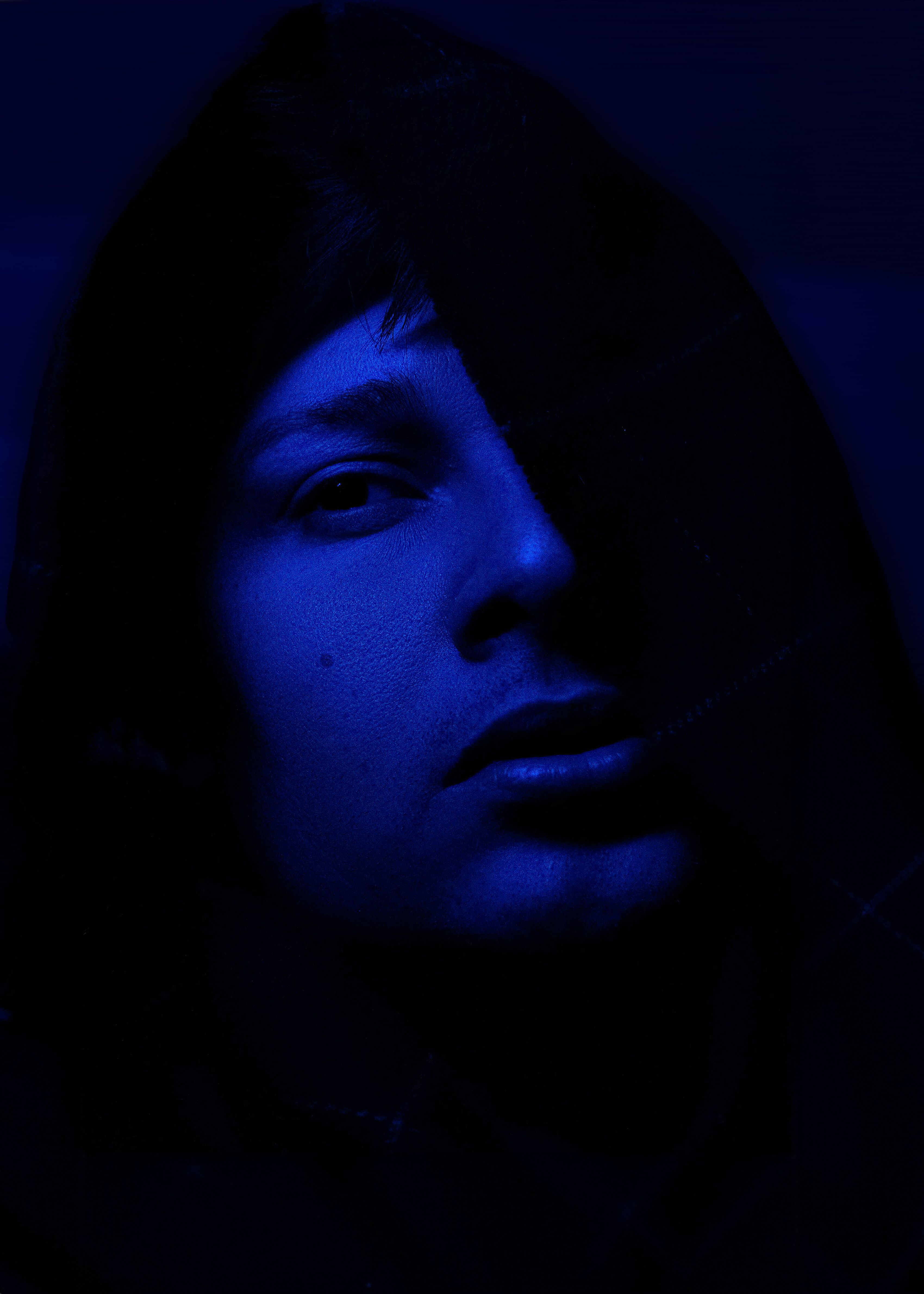 Dramatic Portrait in Moody Blue Light · Free Stock Photo