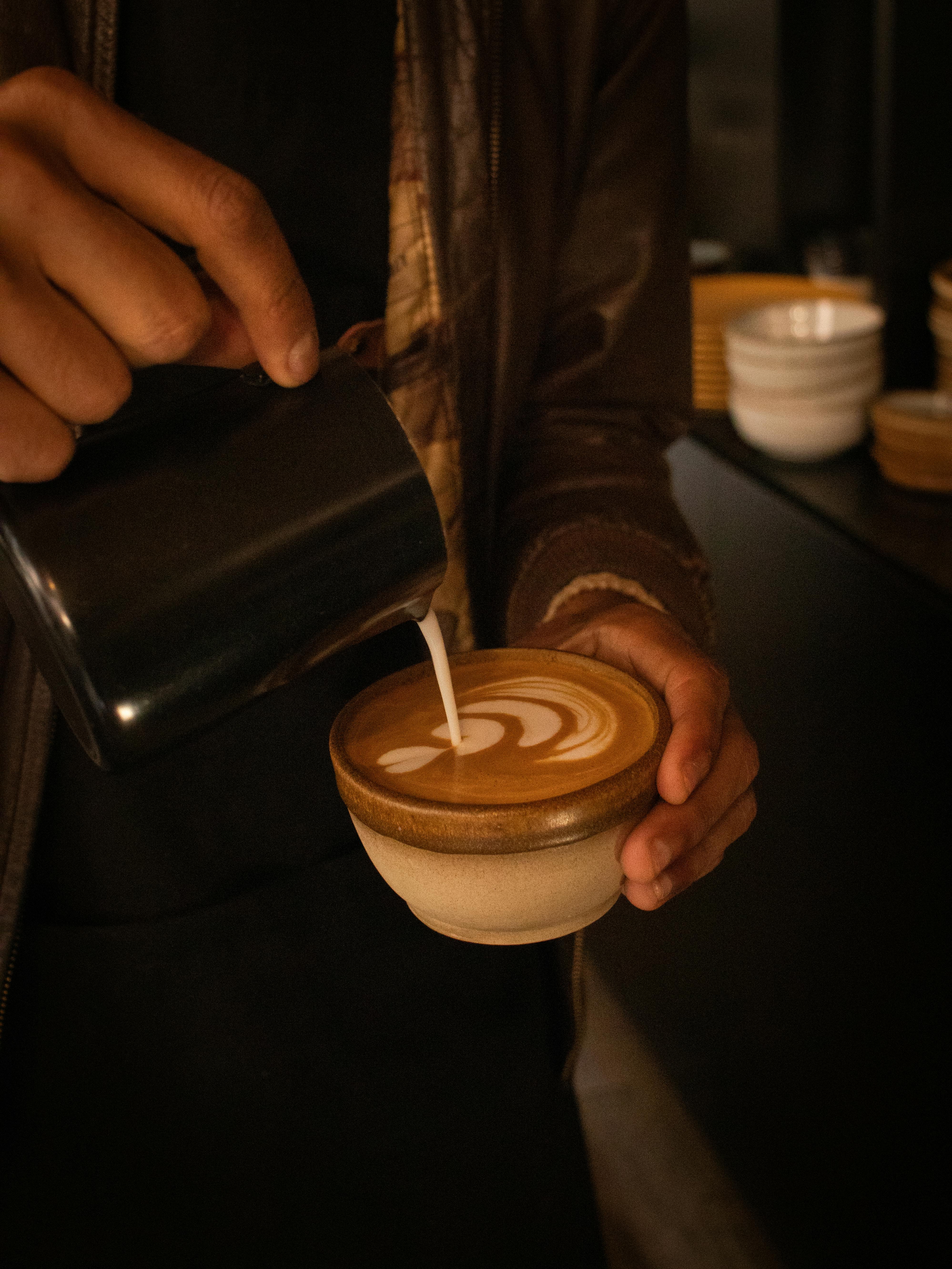 Artistic Latte Art in Cozy Cafe Setting · Free Stock Photo