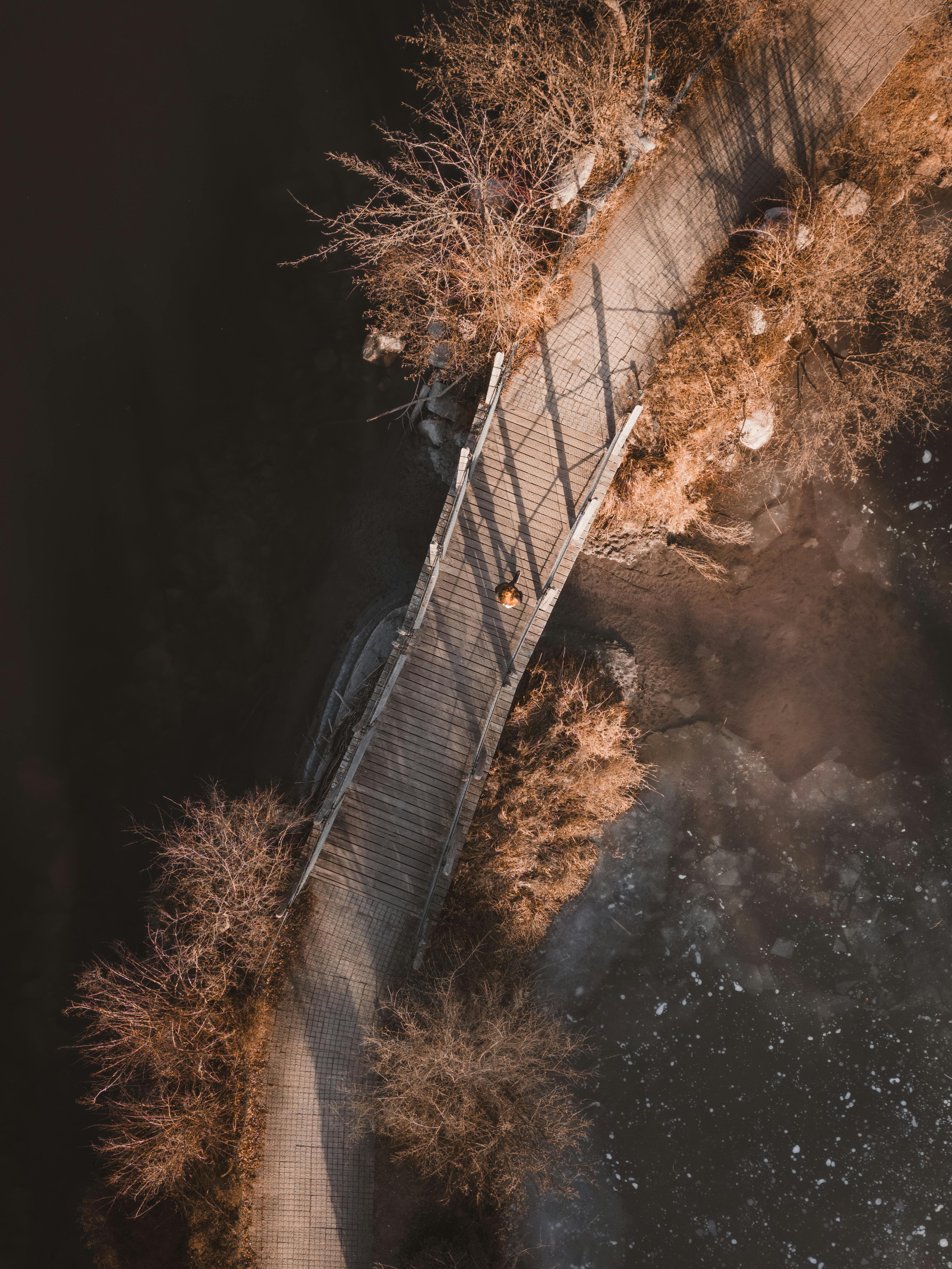 Aerial View of Wooden Bridge Over Frozen River · Free Stock Photo