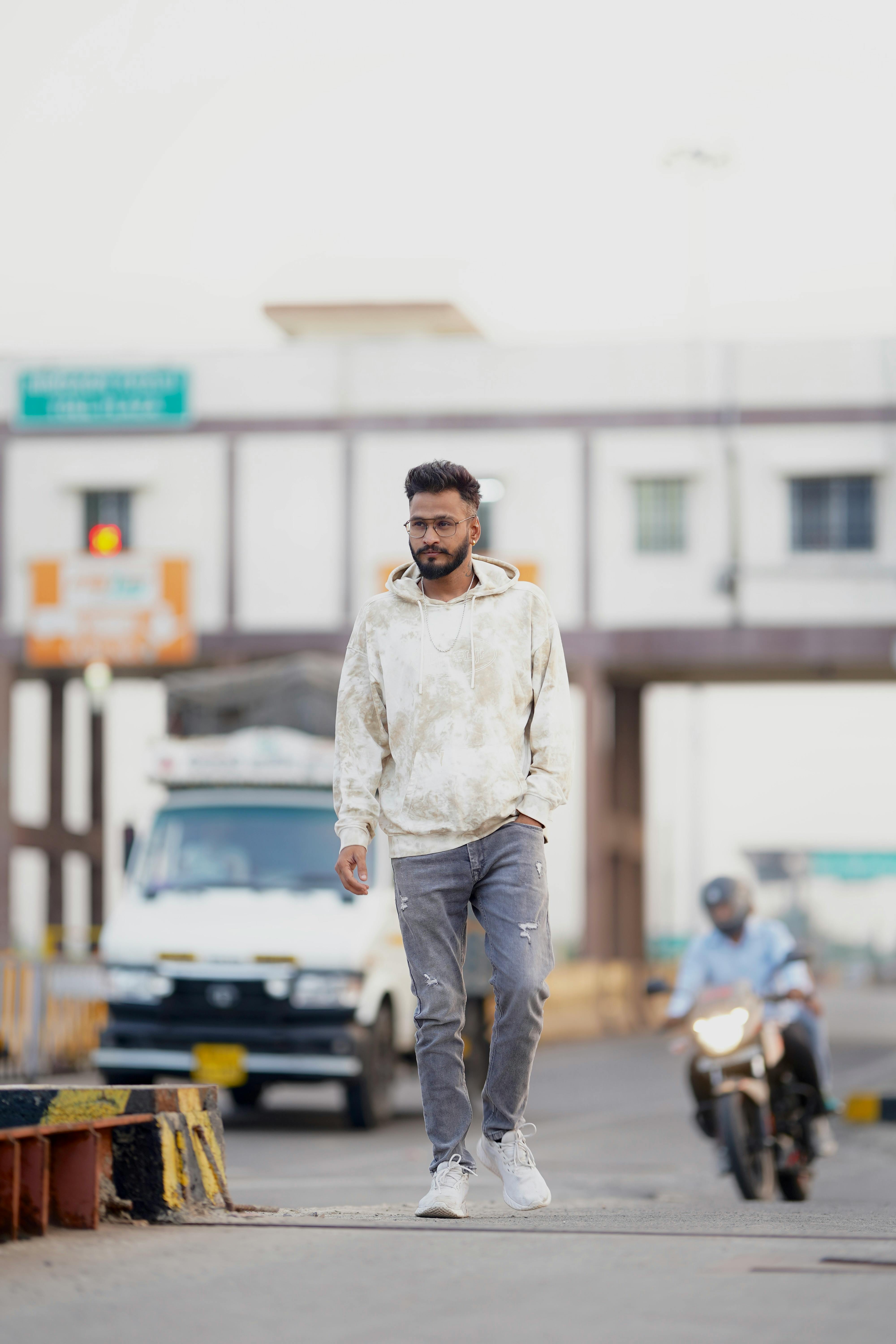 Young Man Walking on Urban Street in Pune · Free Stock Photo