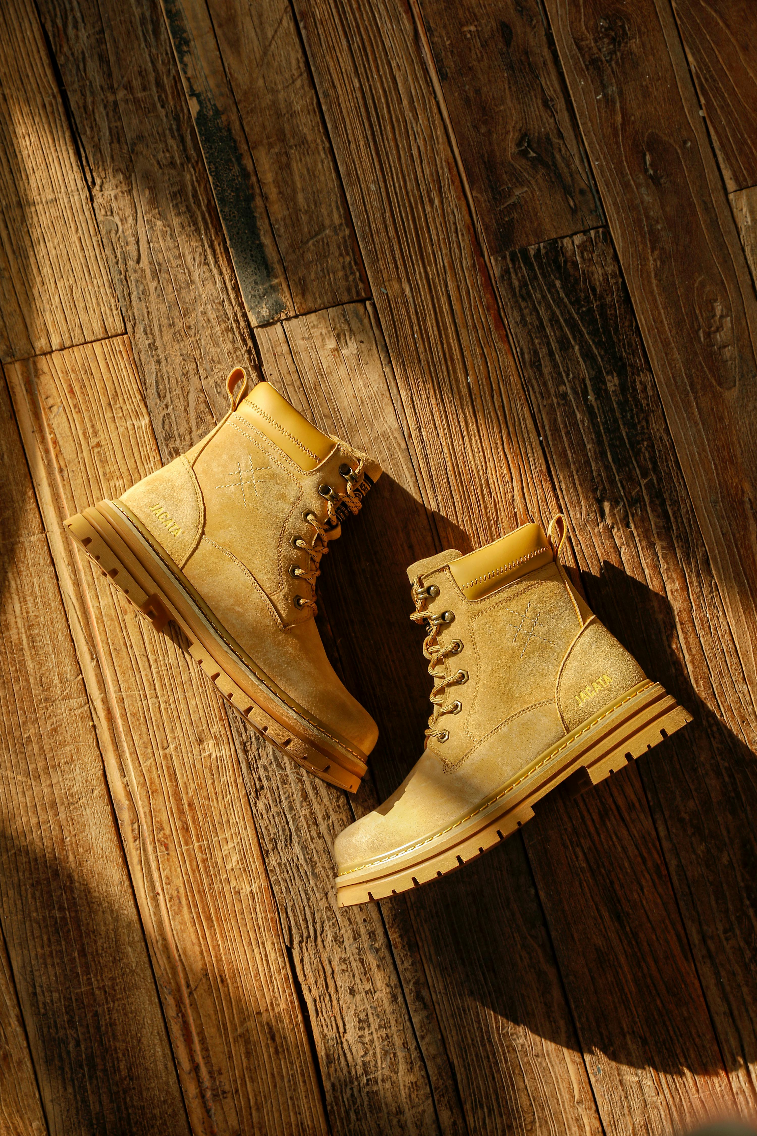 Stylish Tan Work Boots on Wooden Floor · Free Stock Photo