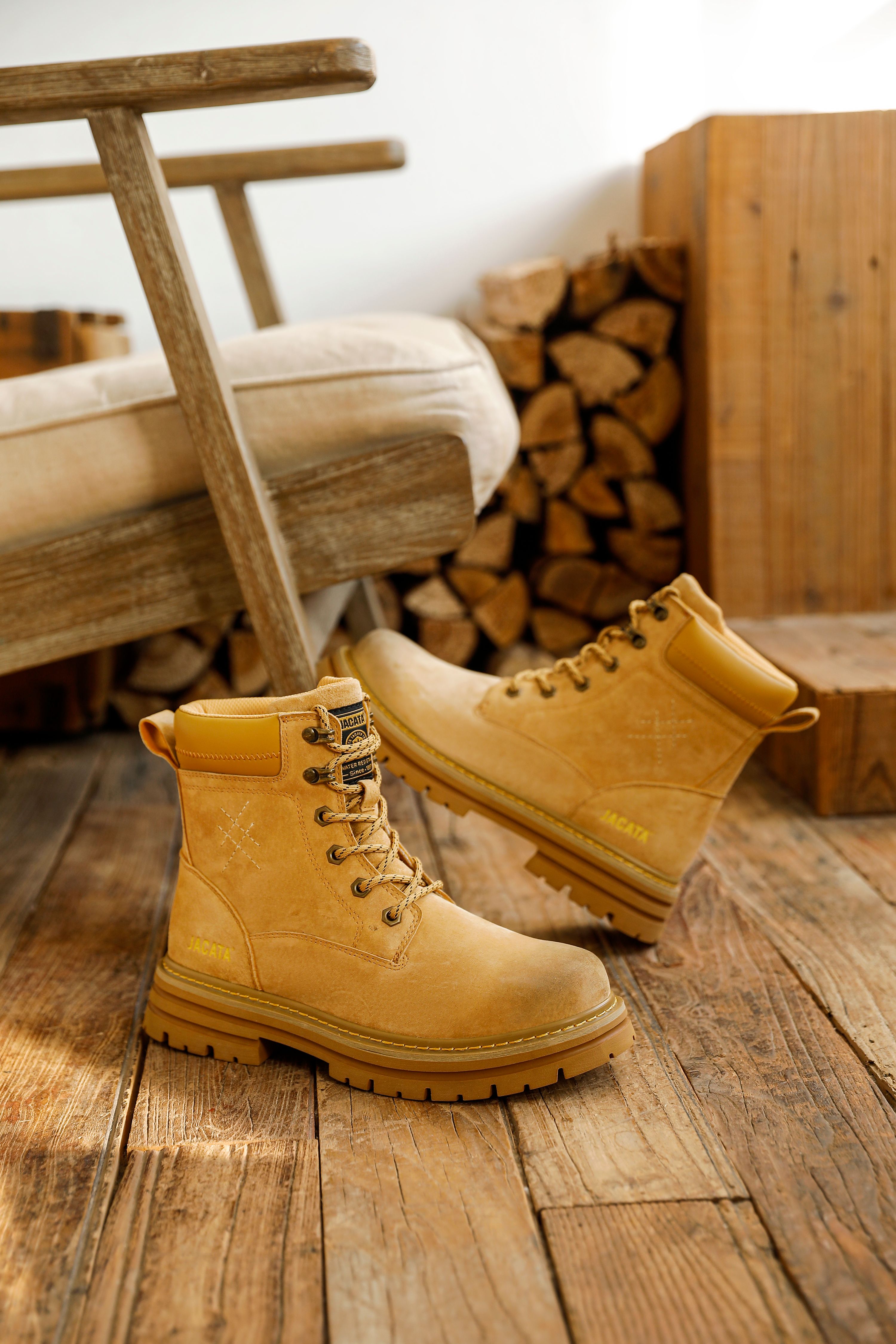 Stylish Leather Boots on Rustic Wooden Floor · Free Stock Photo