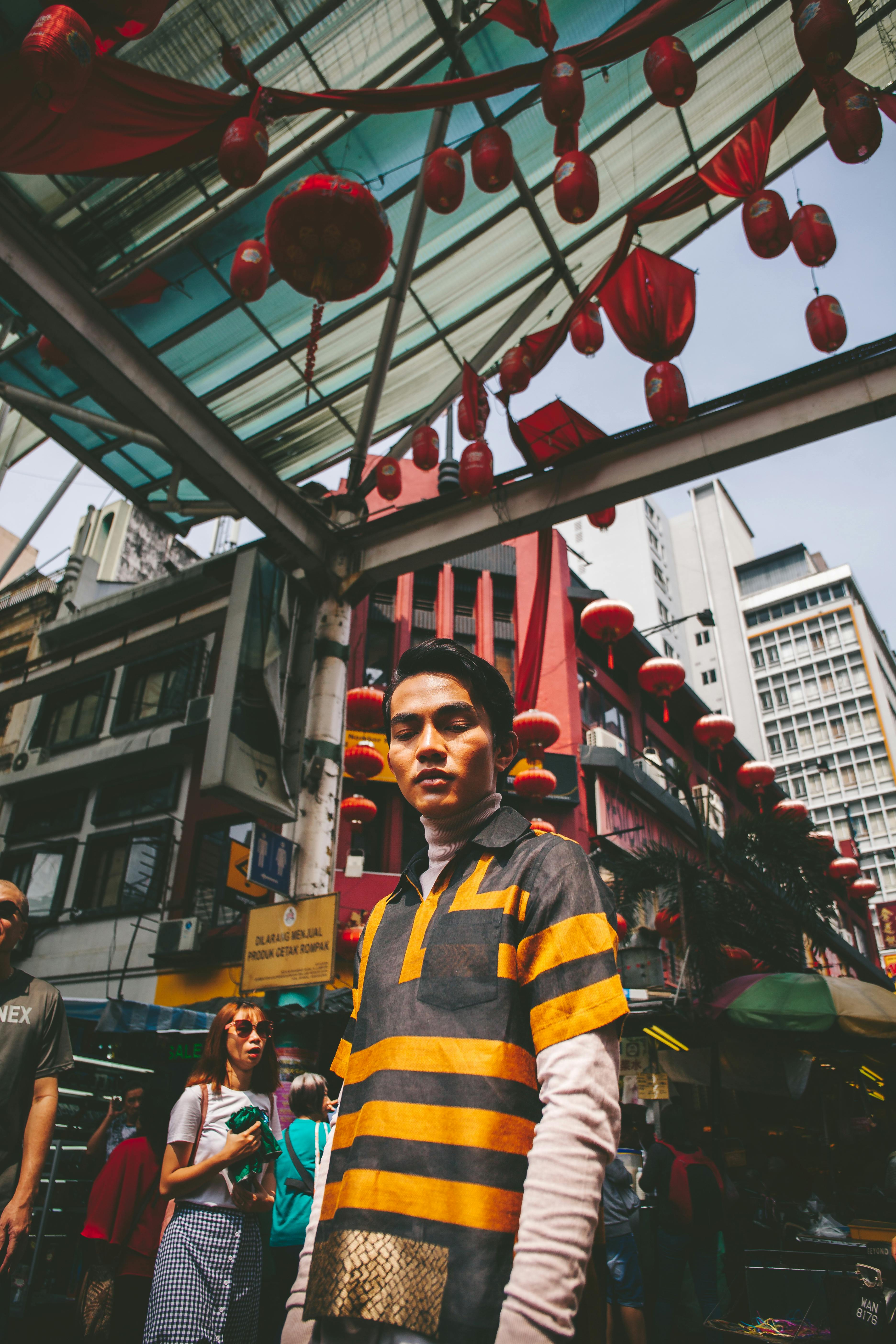Photo of Man Standing Near Buildings · Free Stock Photo