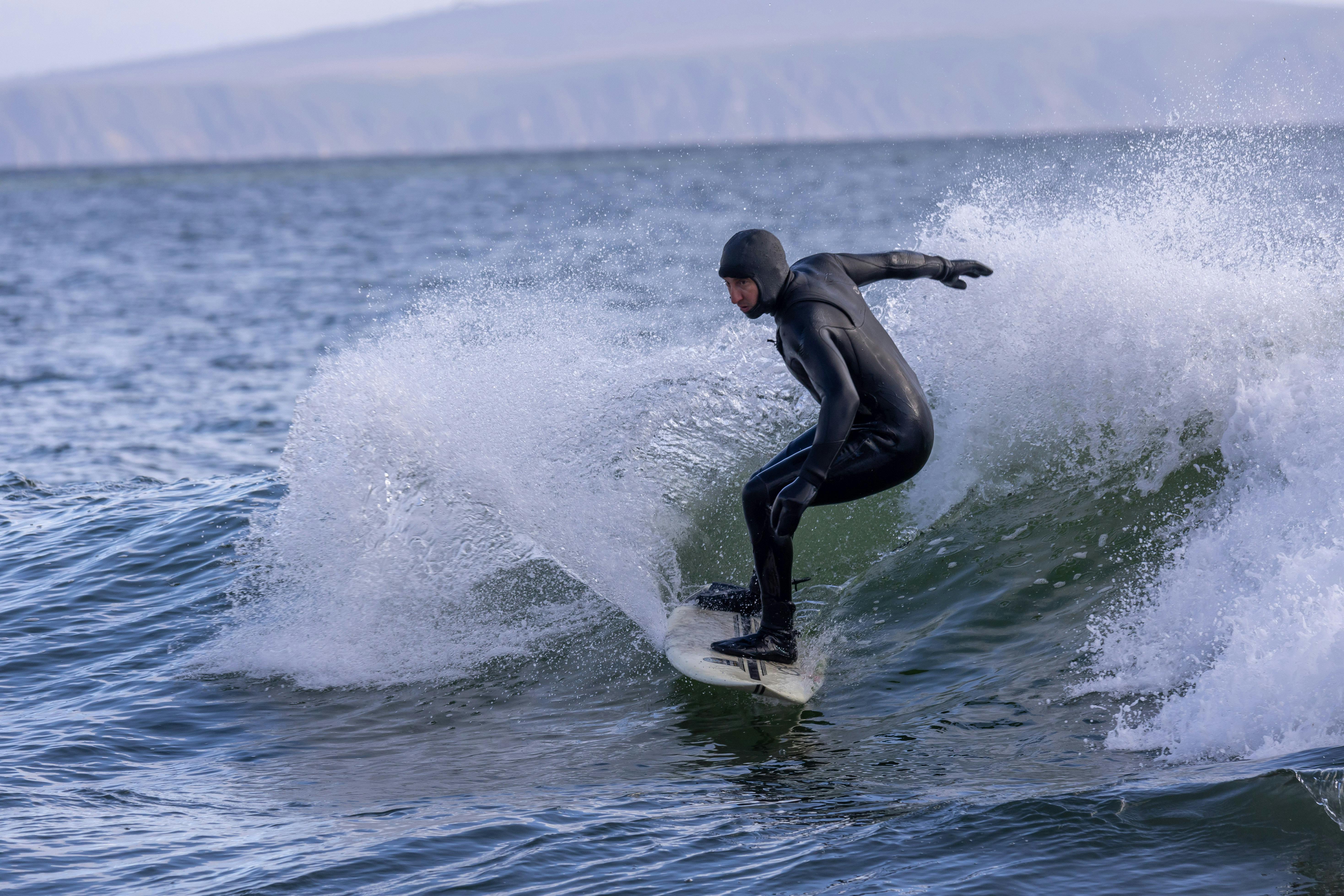 Cold Water Surfing Athlete in Action · Free Stock Photo
